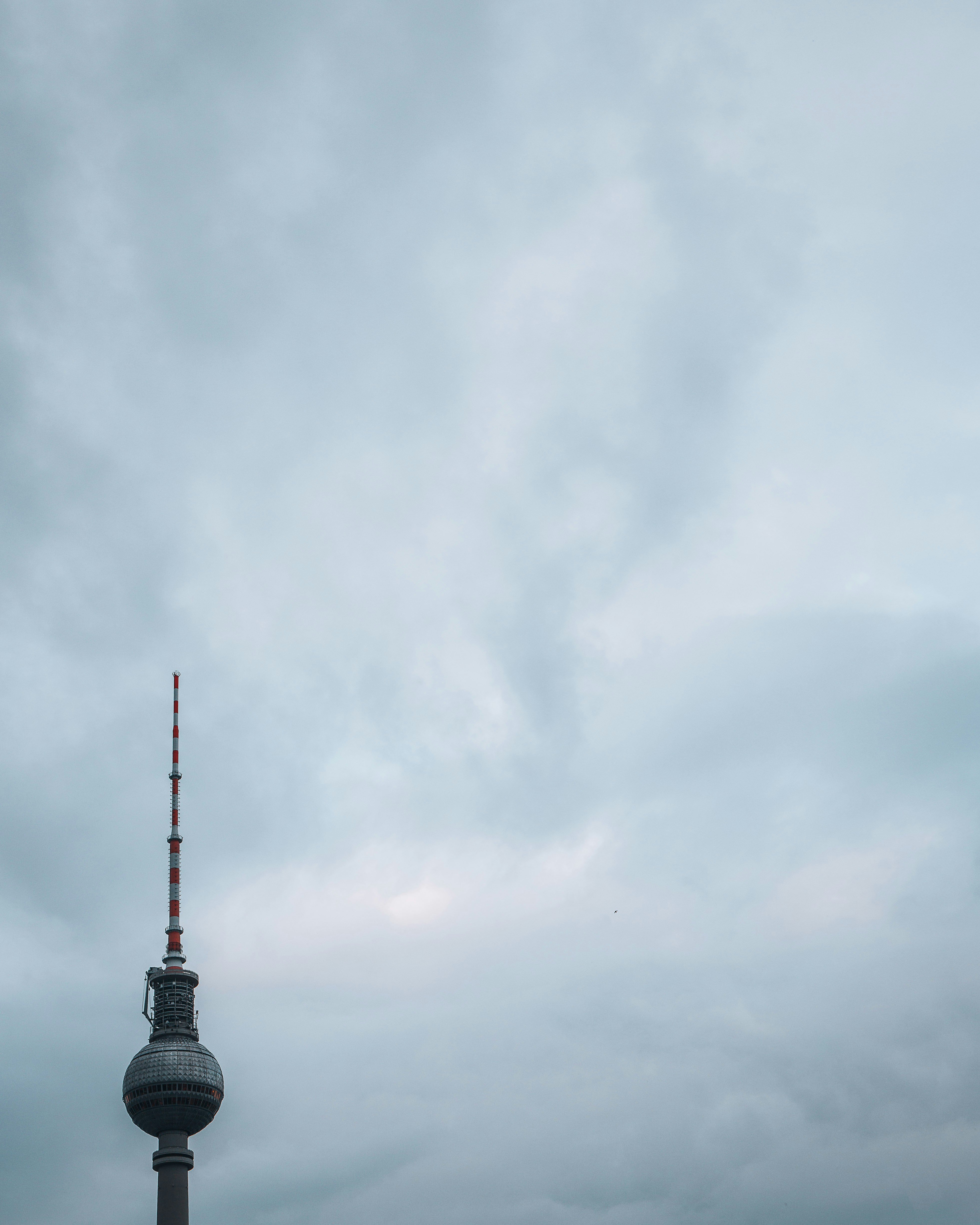 a tall tower with a red antenna