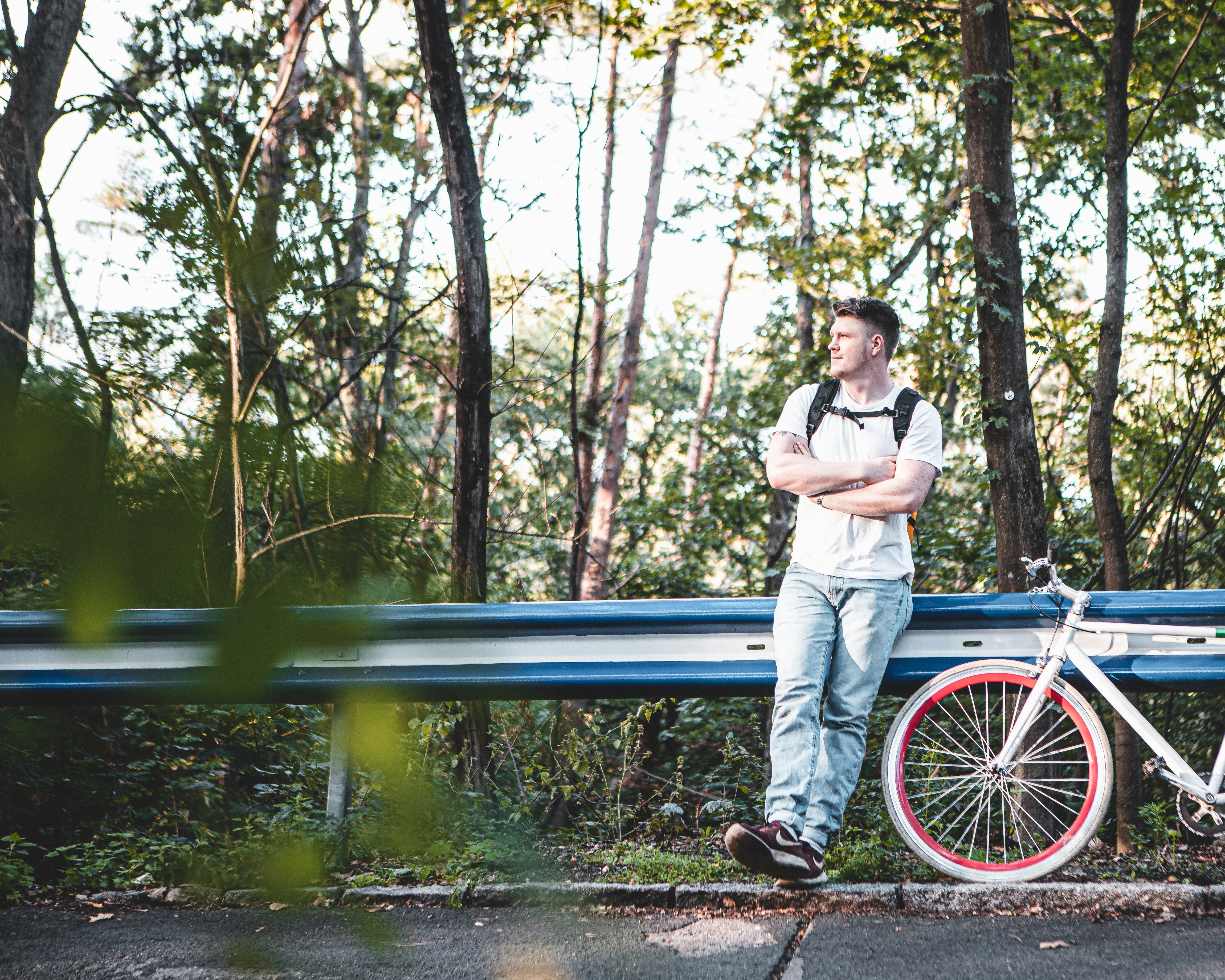 Guardrail Reverie: Quiet Moment with a Red-Wheeled Bicycle