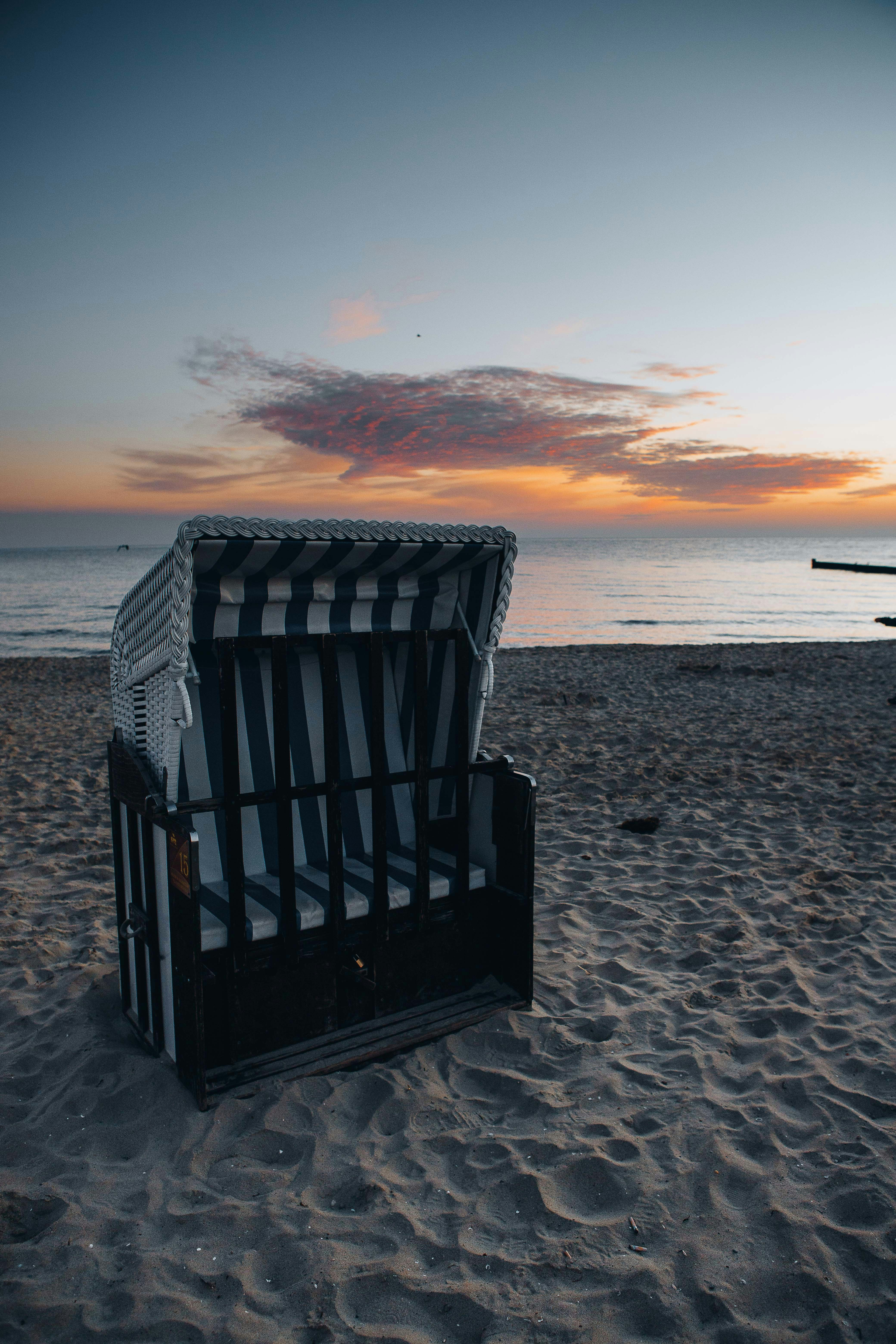 Stripes at Sunset: Beach Chair Framed by Quiet Seas