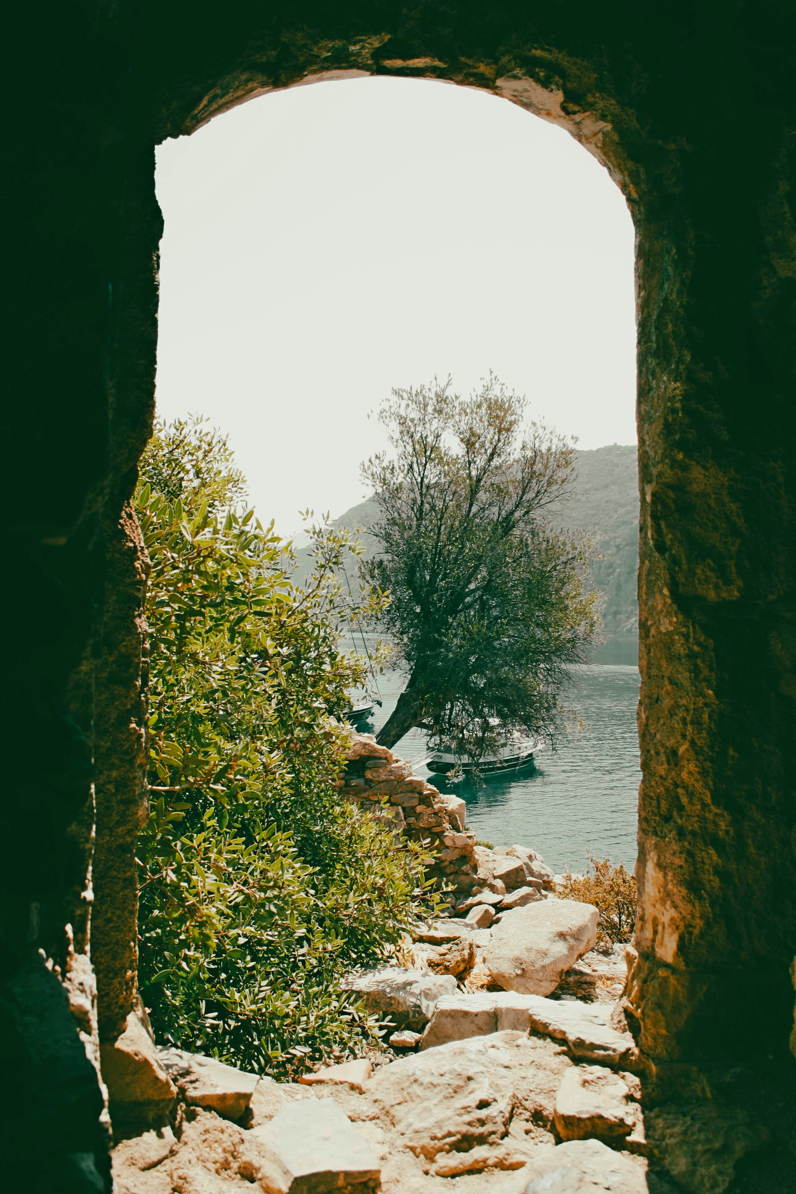 Archway Vista: A Stone Frame Over a Tranquil Lake