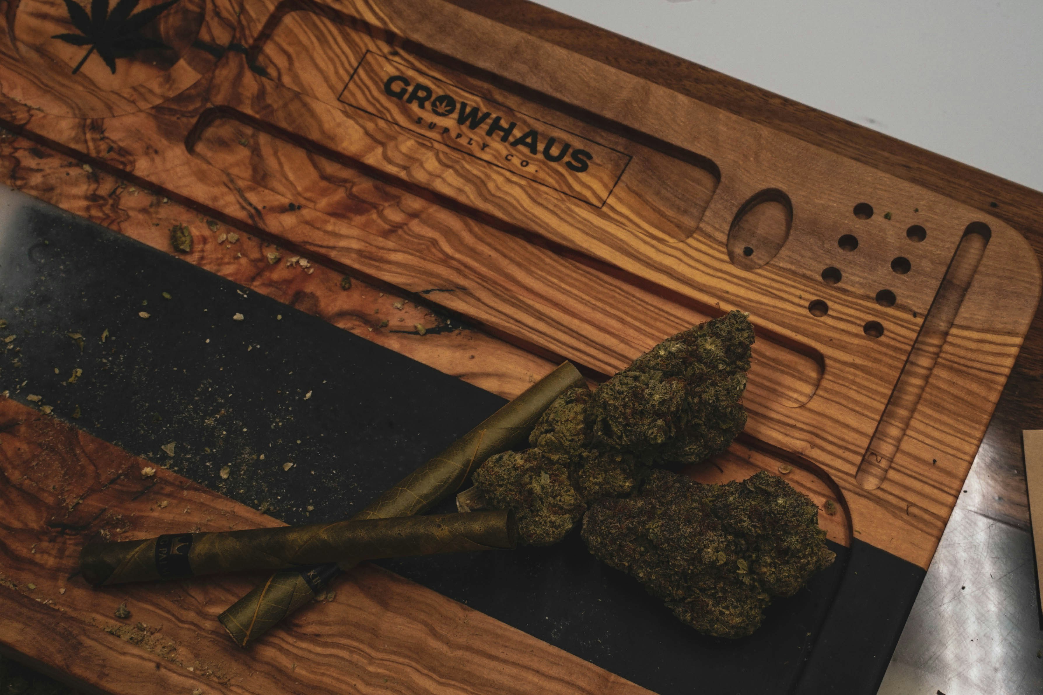 Cannabis Buds Rest on an Engraved Growhaus Cutting Board