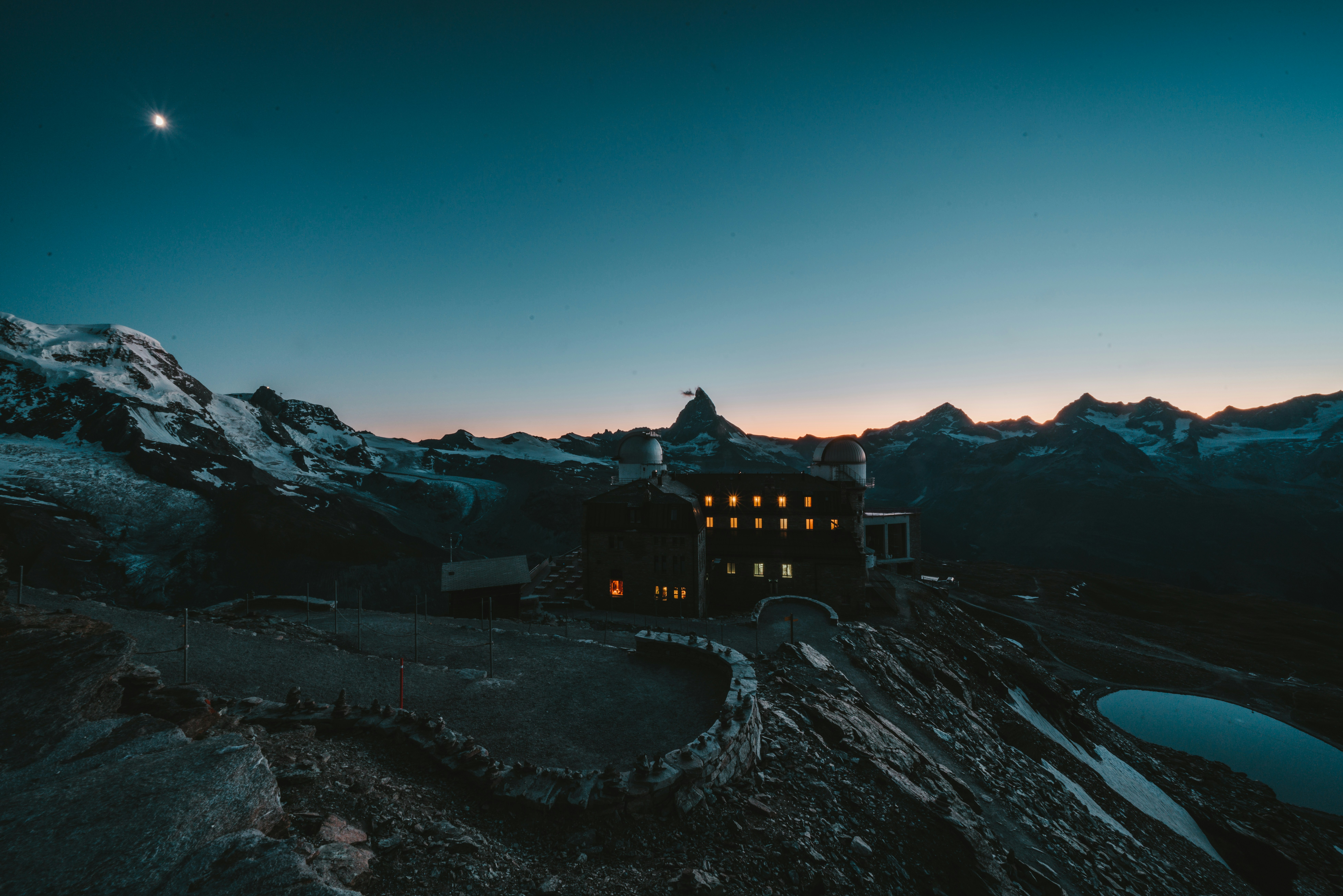 Moonlit Refuge on a Windswept Alpine Ridge