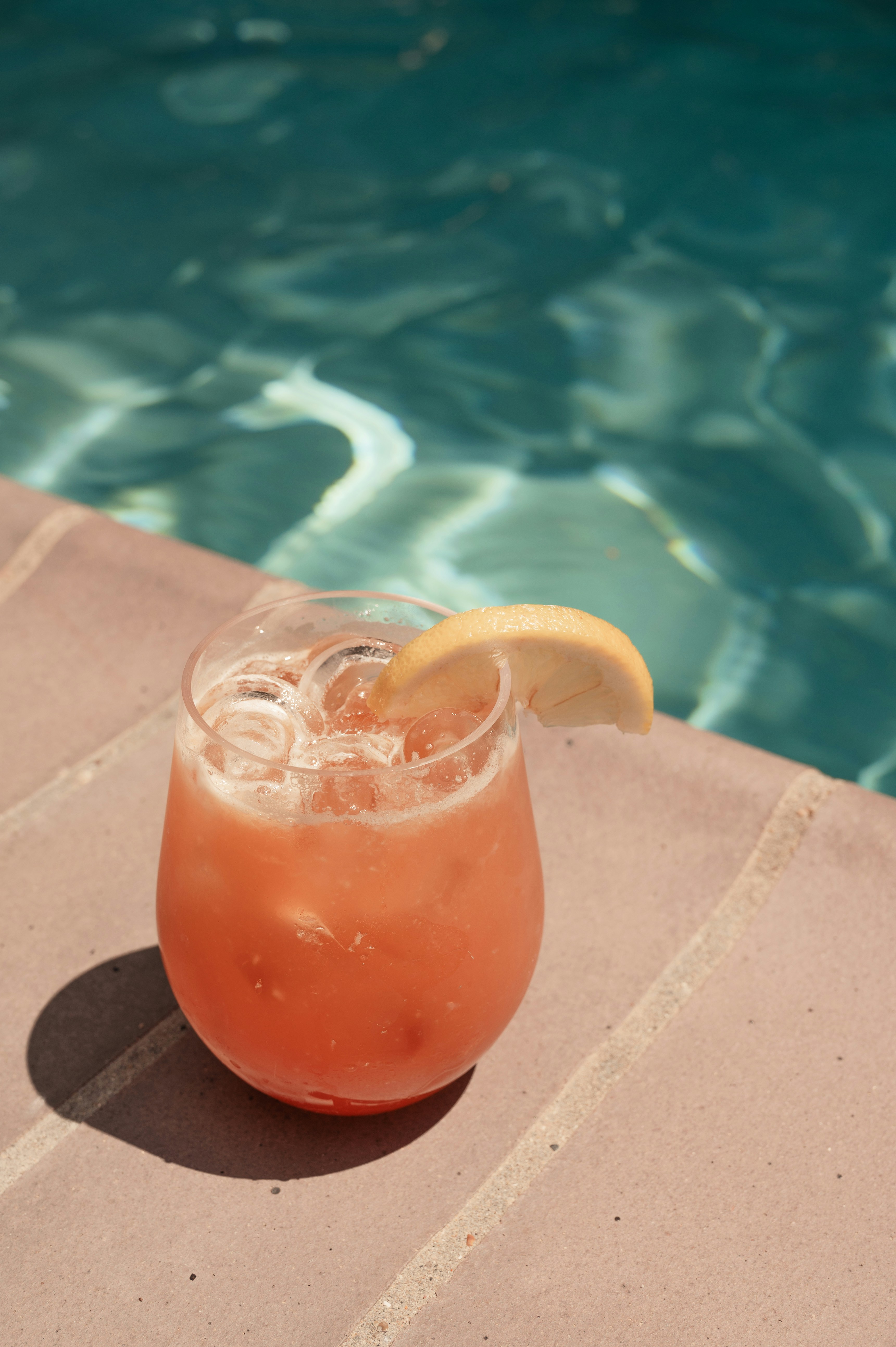Sunlit Poolside Citrus: Coral Cocktail by the Tile Edge