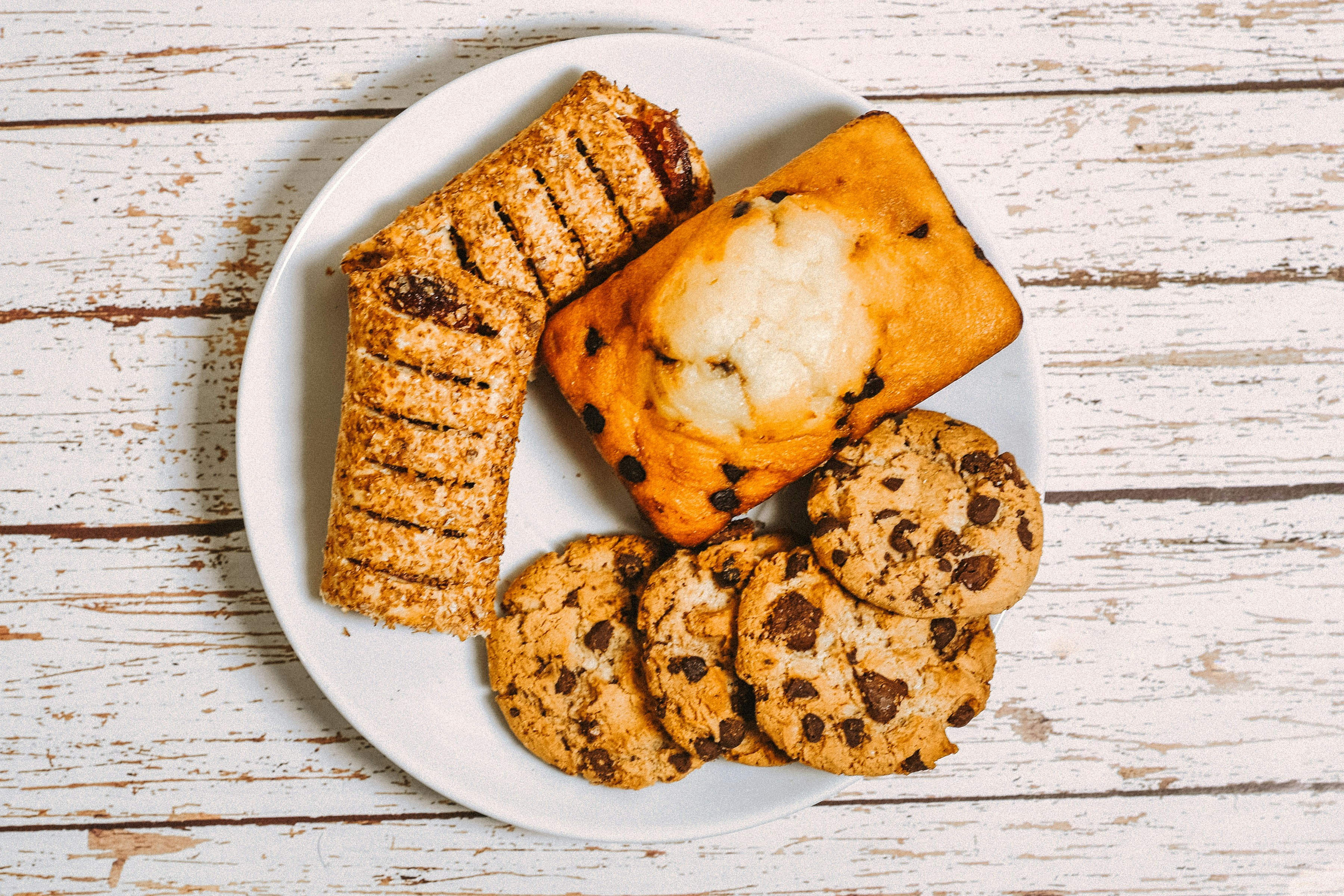 Pane of Warmth: AssortedCookies on a Weathered Plate