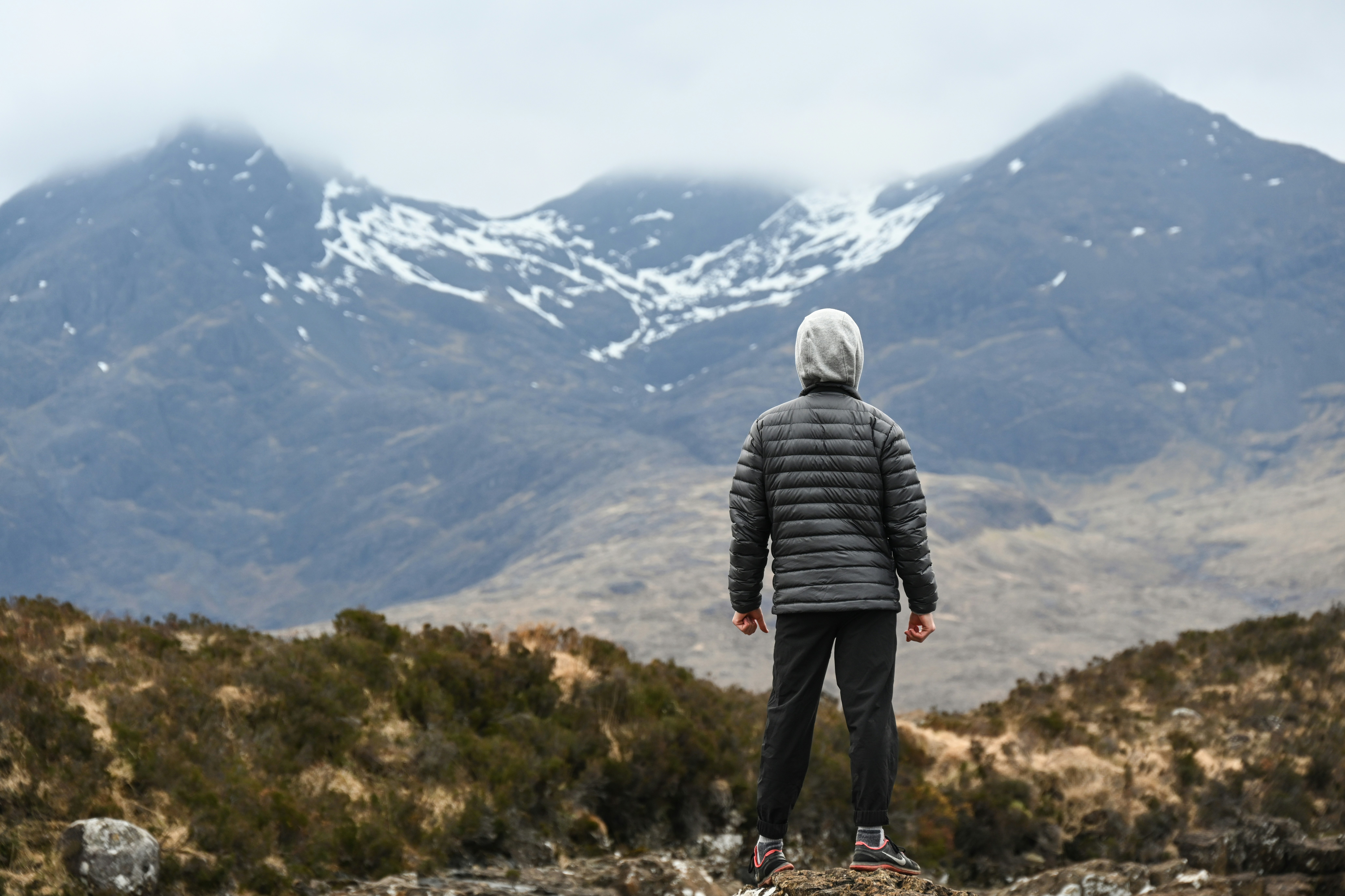 Hiker in a Mountain Mist: A lone silhouette before frost-kissed peaks