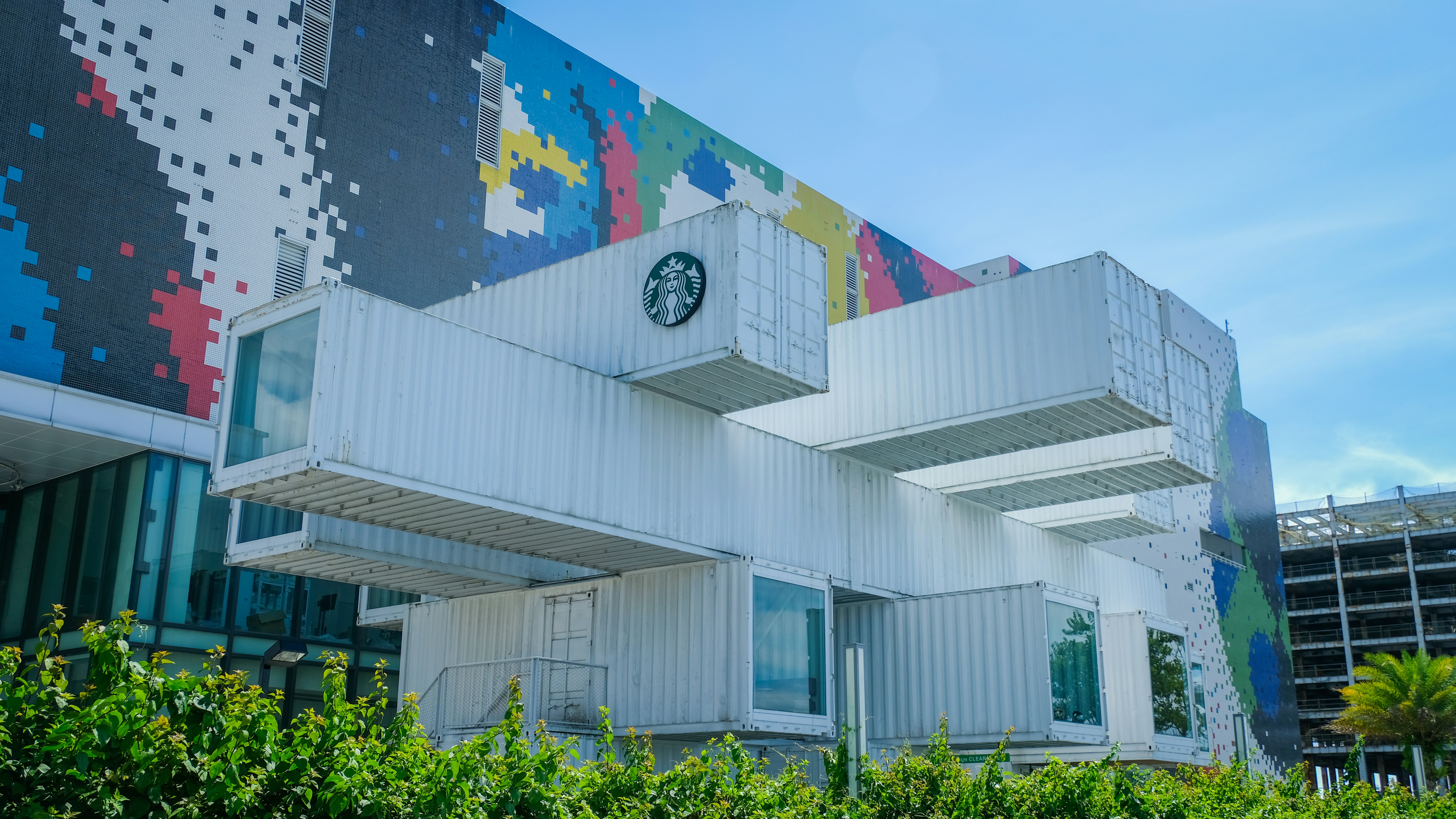 Clocked Cubes Under a Colorful Mosaic Facade