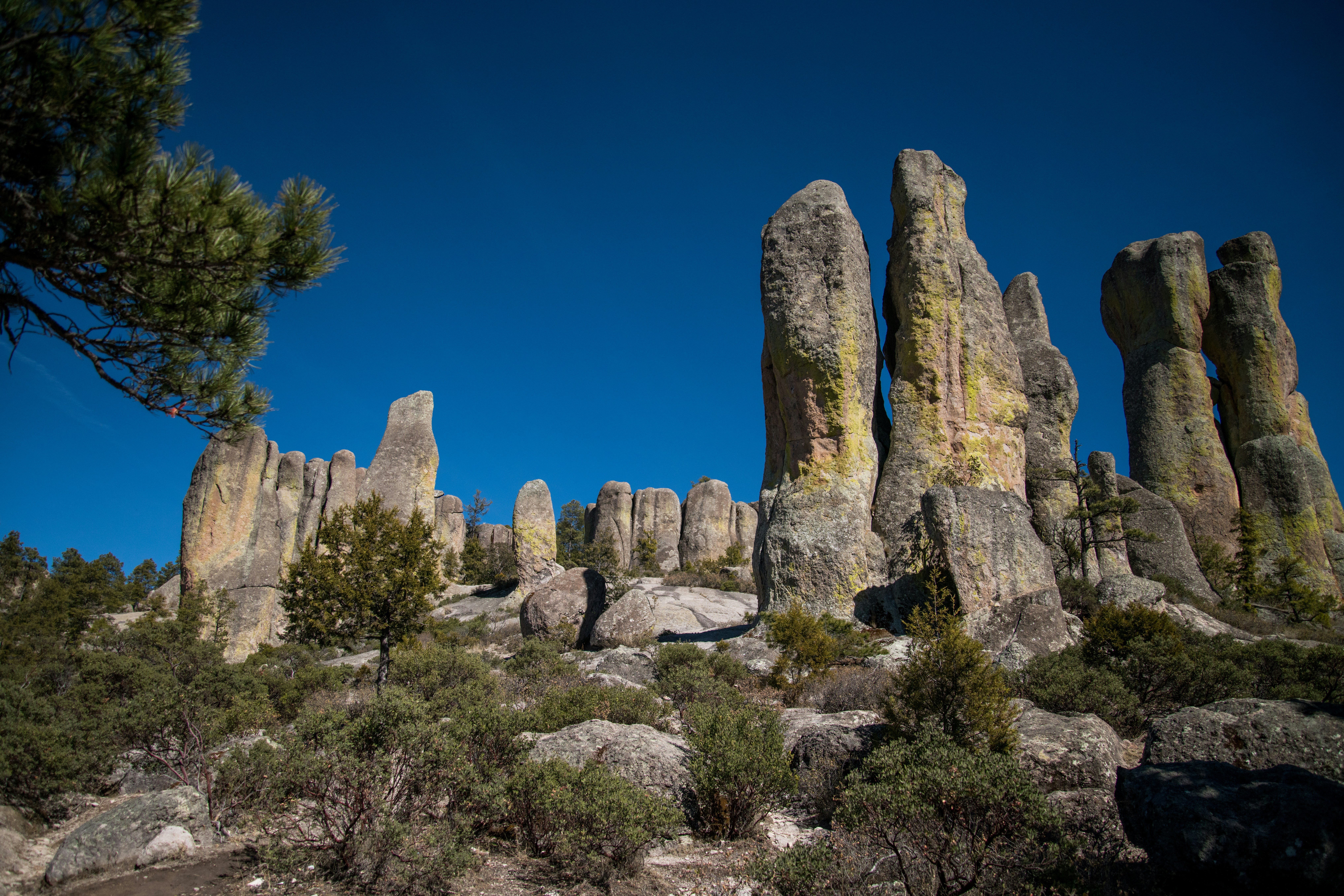 A group of tall rocks photo – Free Blue Image on Unsplash