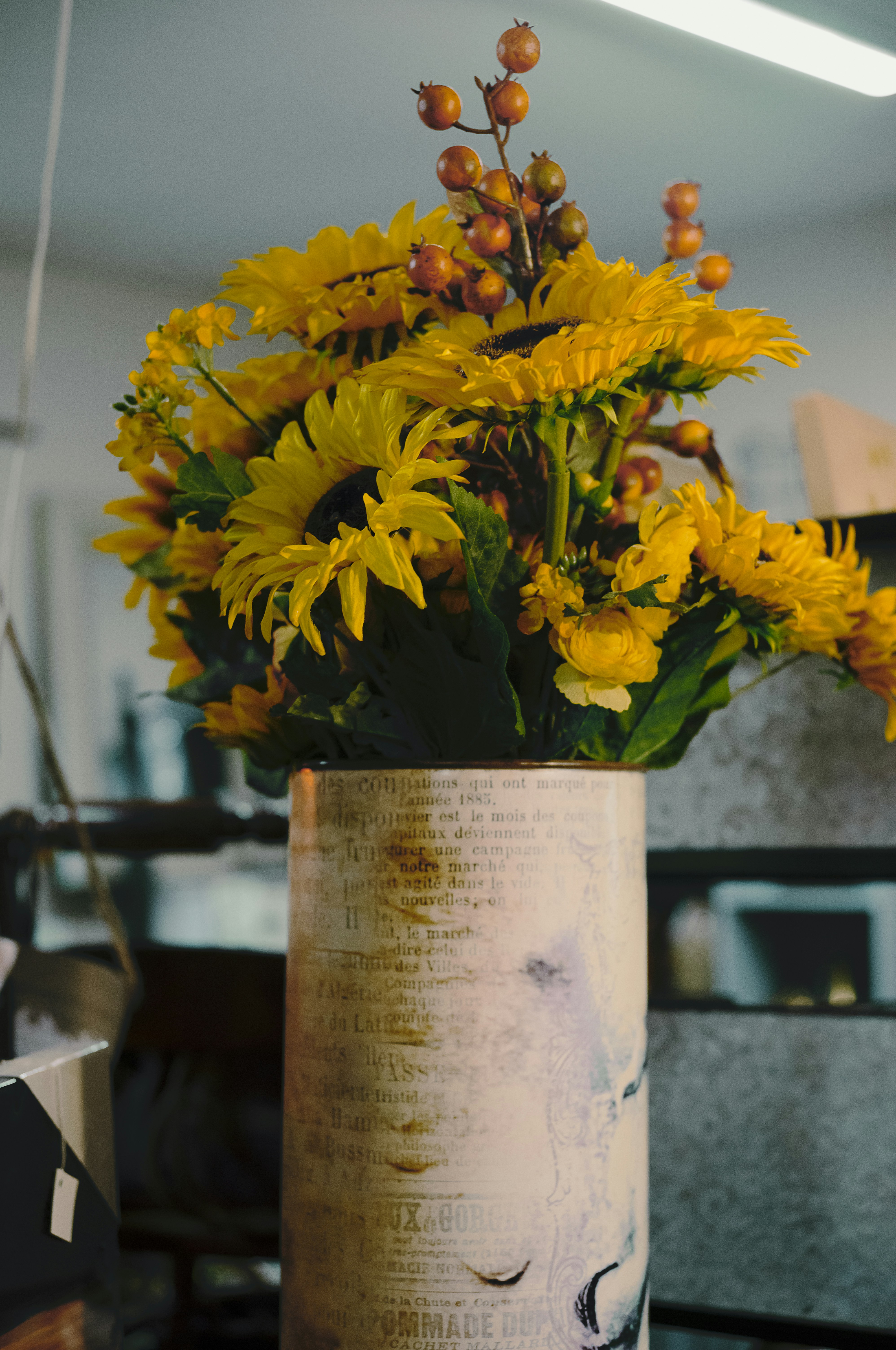 Sunflowers in a Text-Printed Vase under Fluorescent Office Light