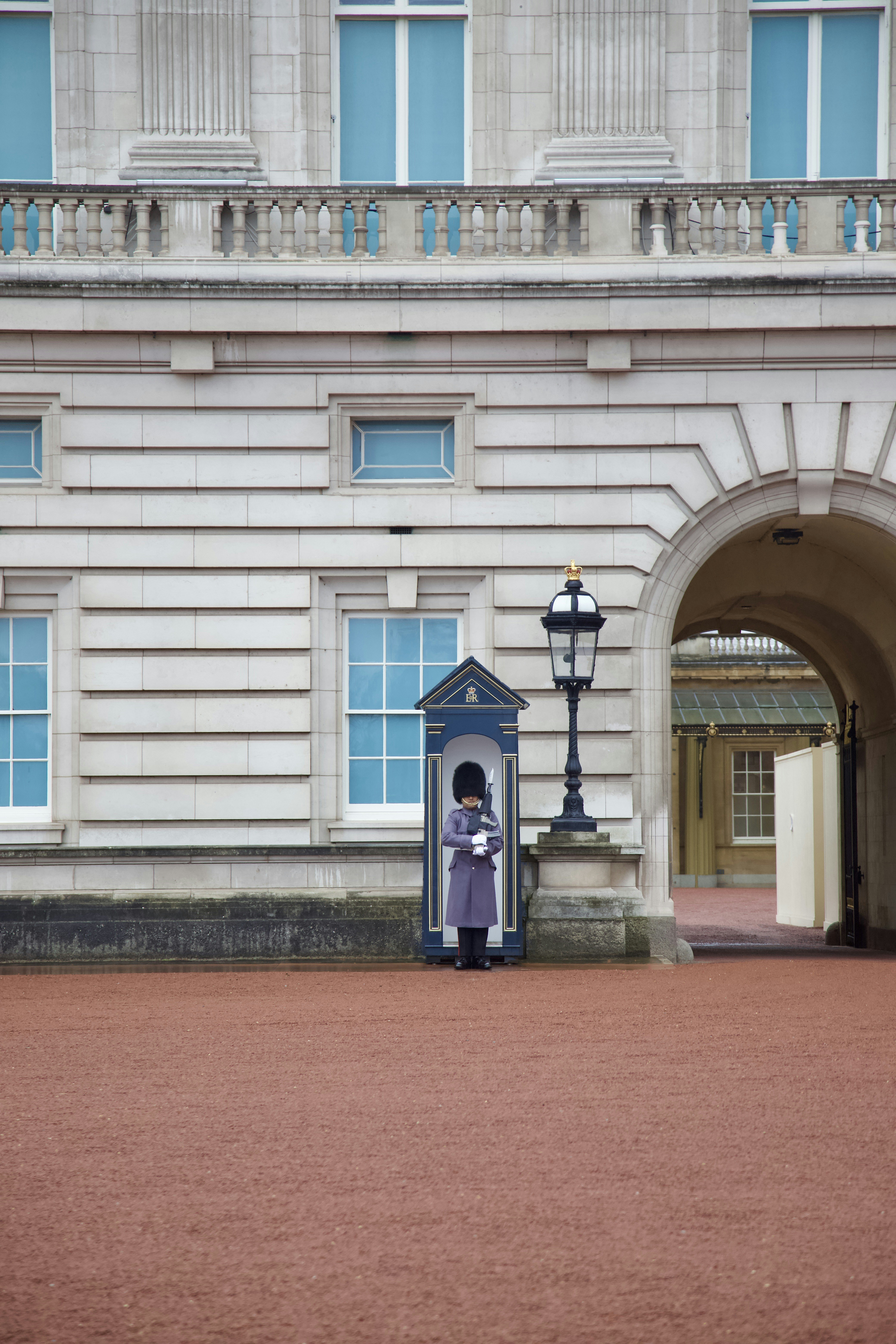 Guard at the Archway: A Quiet Post Outside a Historic Facade