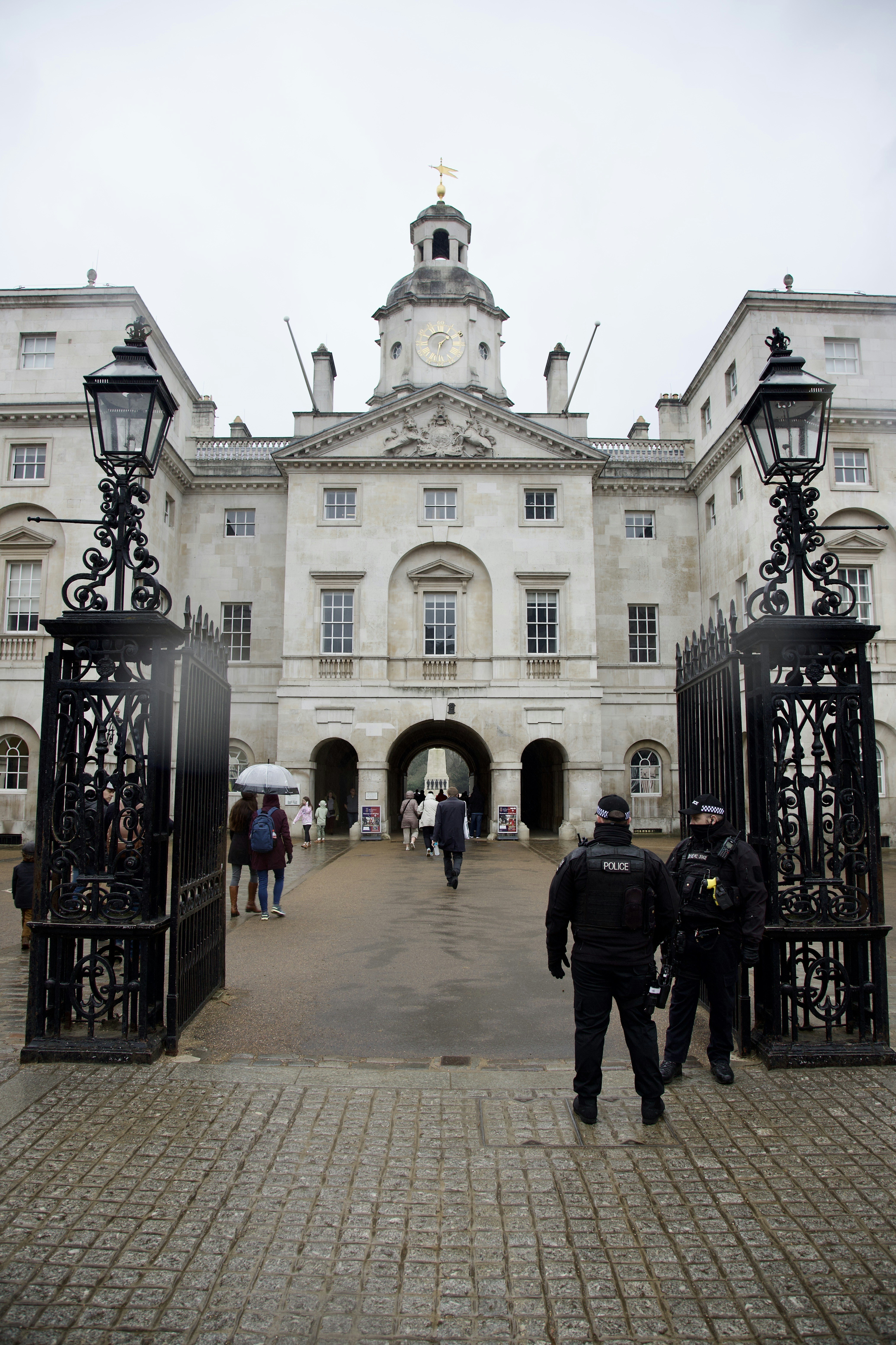 Guardians at the Grand Arch: Weathered Facade and Watchful Officers