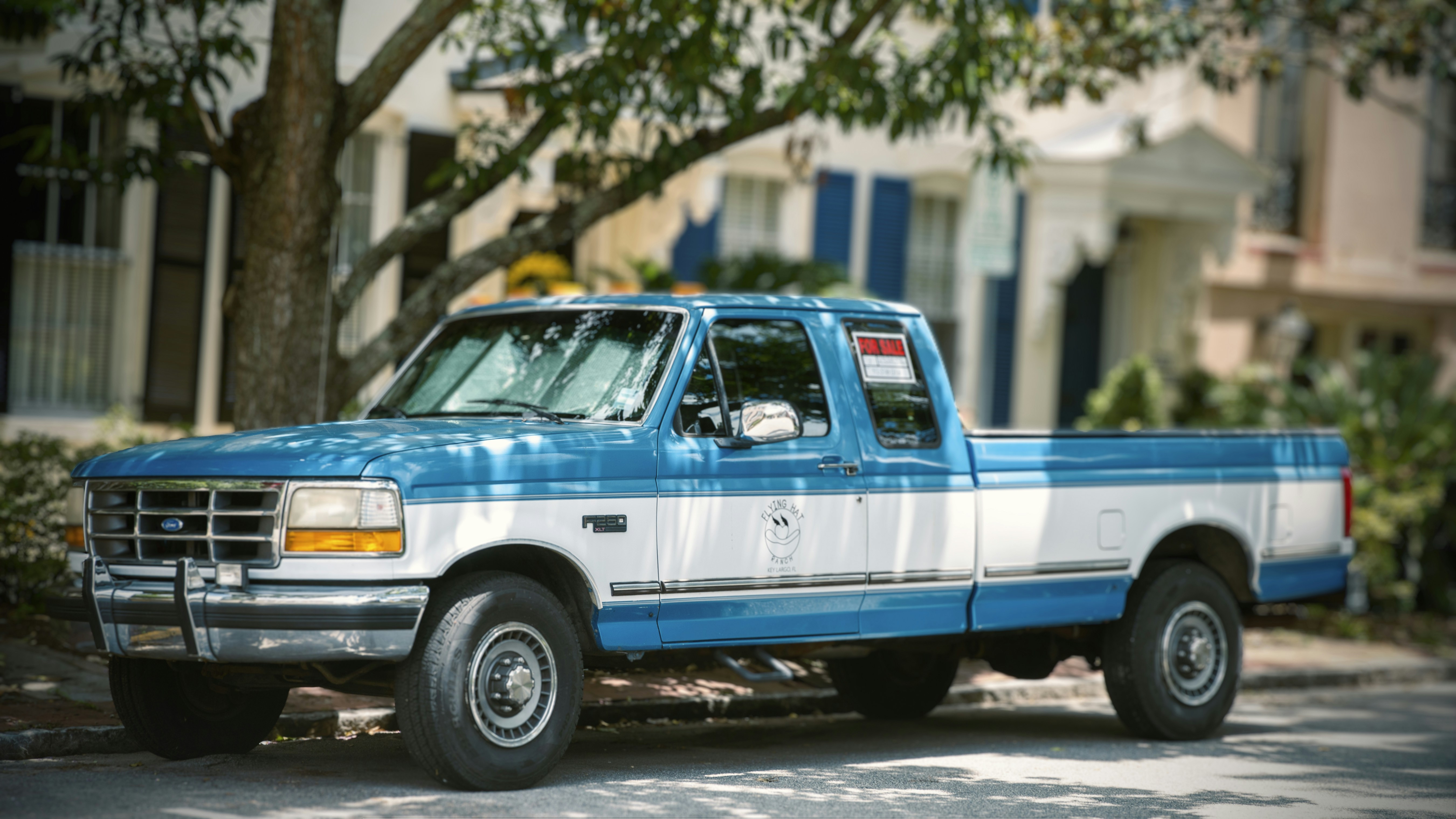 A blue truck parked on the side of the road photo – Free Savannah Image ...