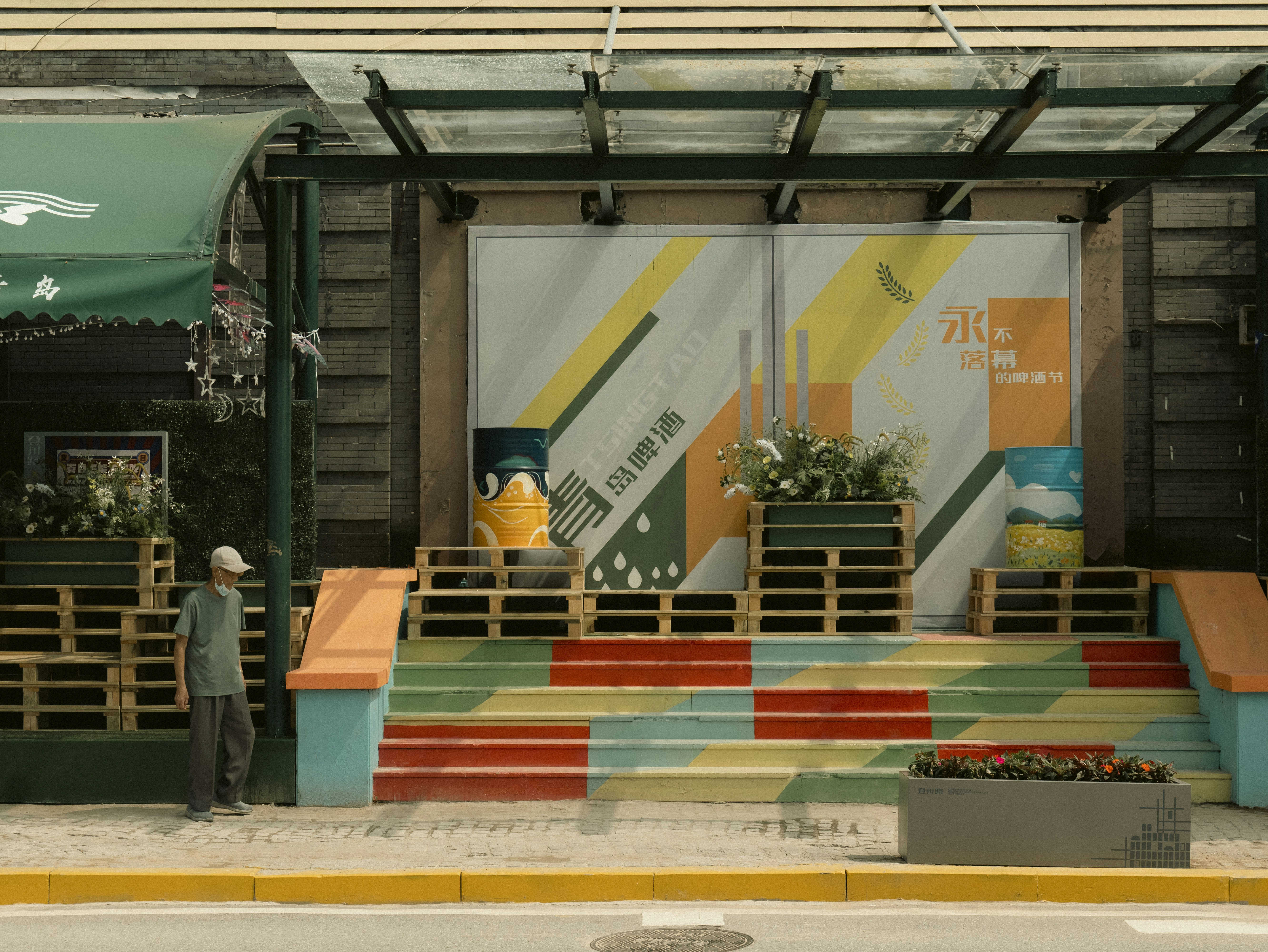 a person standing in front of a building with a yellow and blue sign