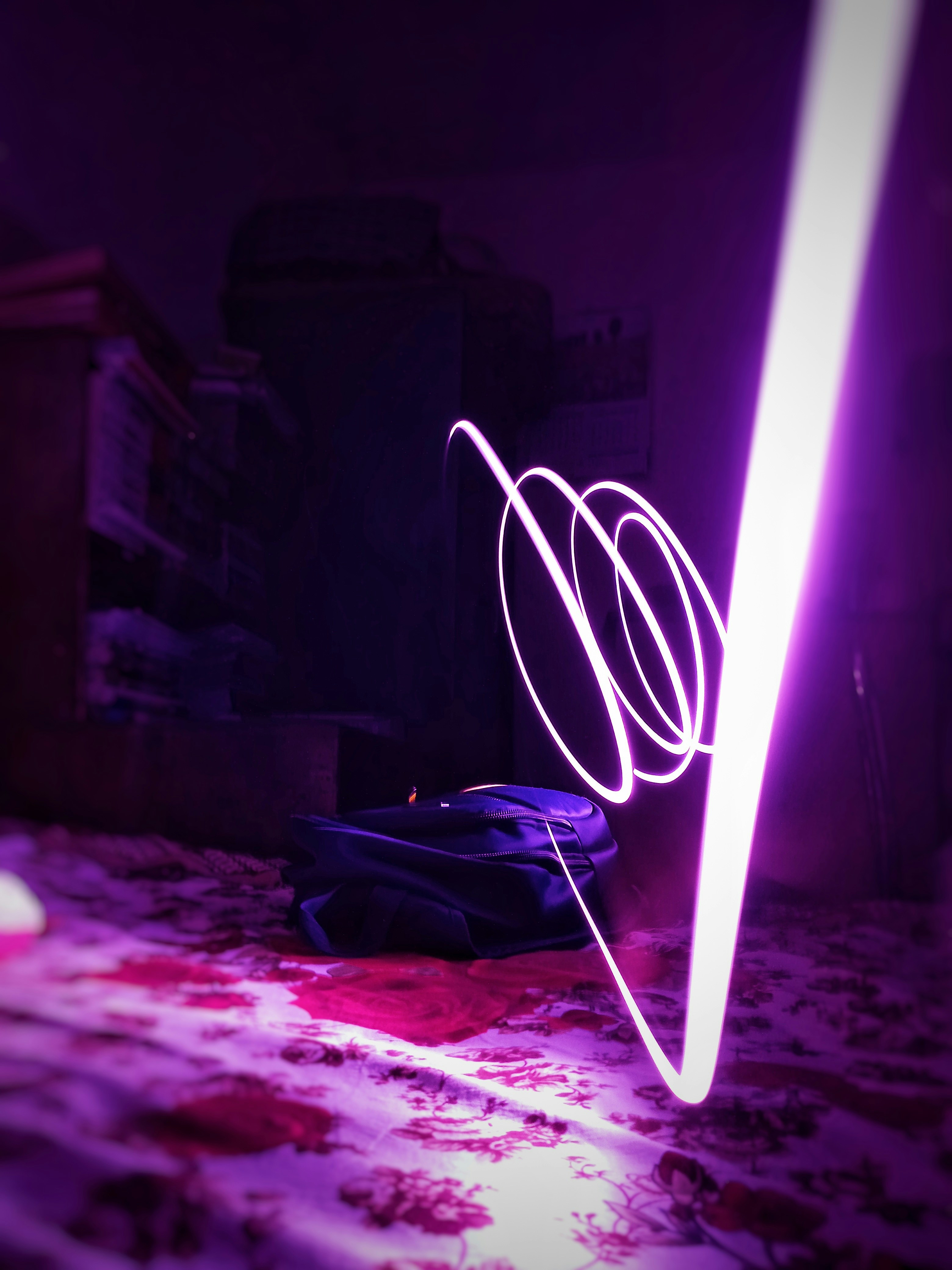 Helical Neon in a Quiet Room: Purple Light Trails Across a Rug