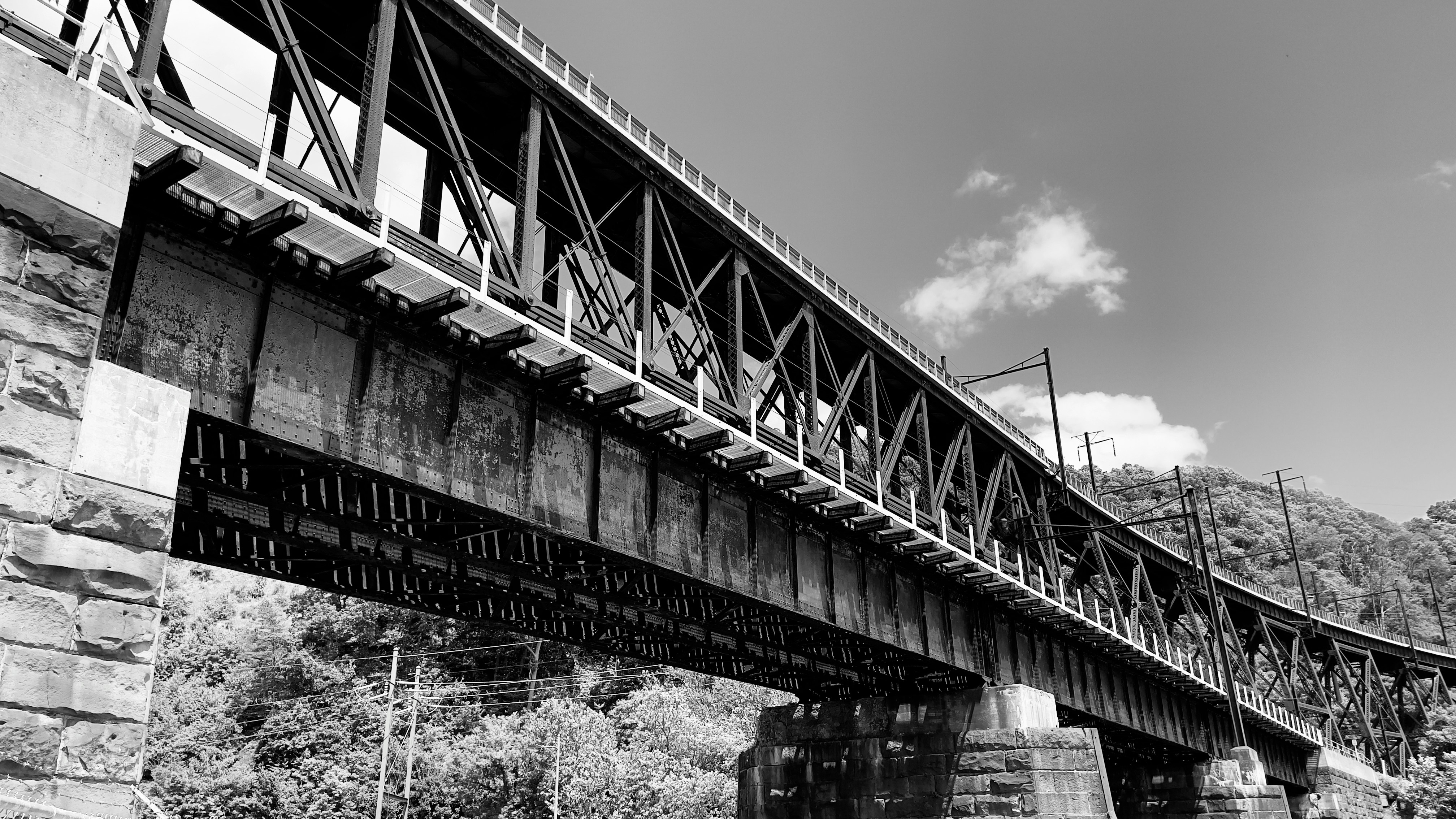 A bridge with a stone wall photo – Free Safe harbor bridge Image on ...