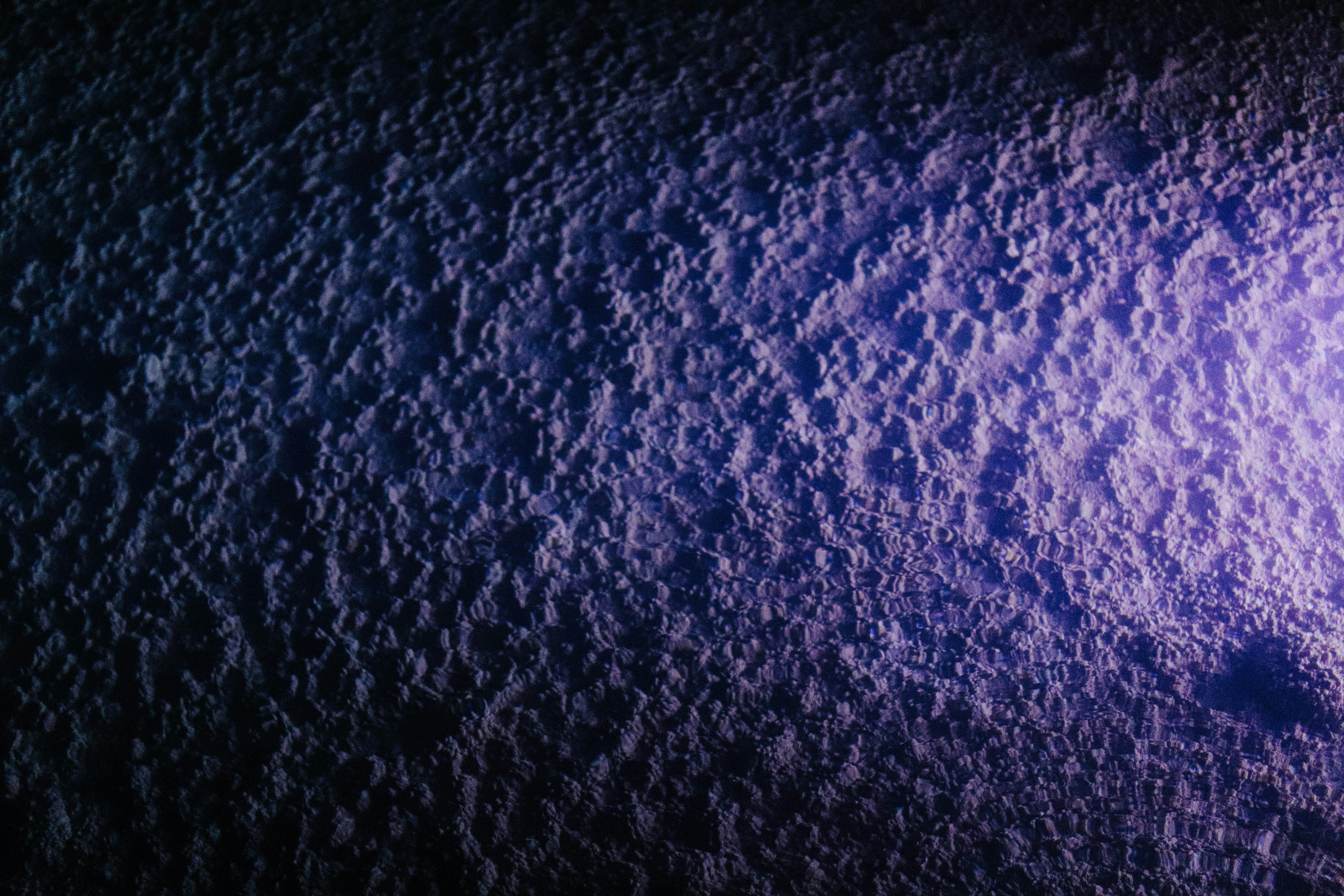 Neon Frost Texture: Purple Light on a Granular Surface