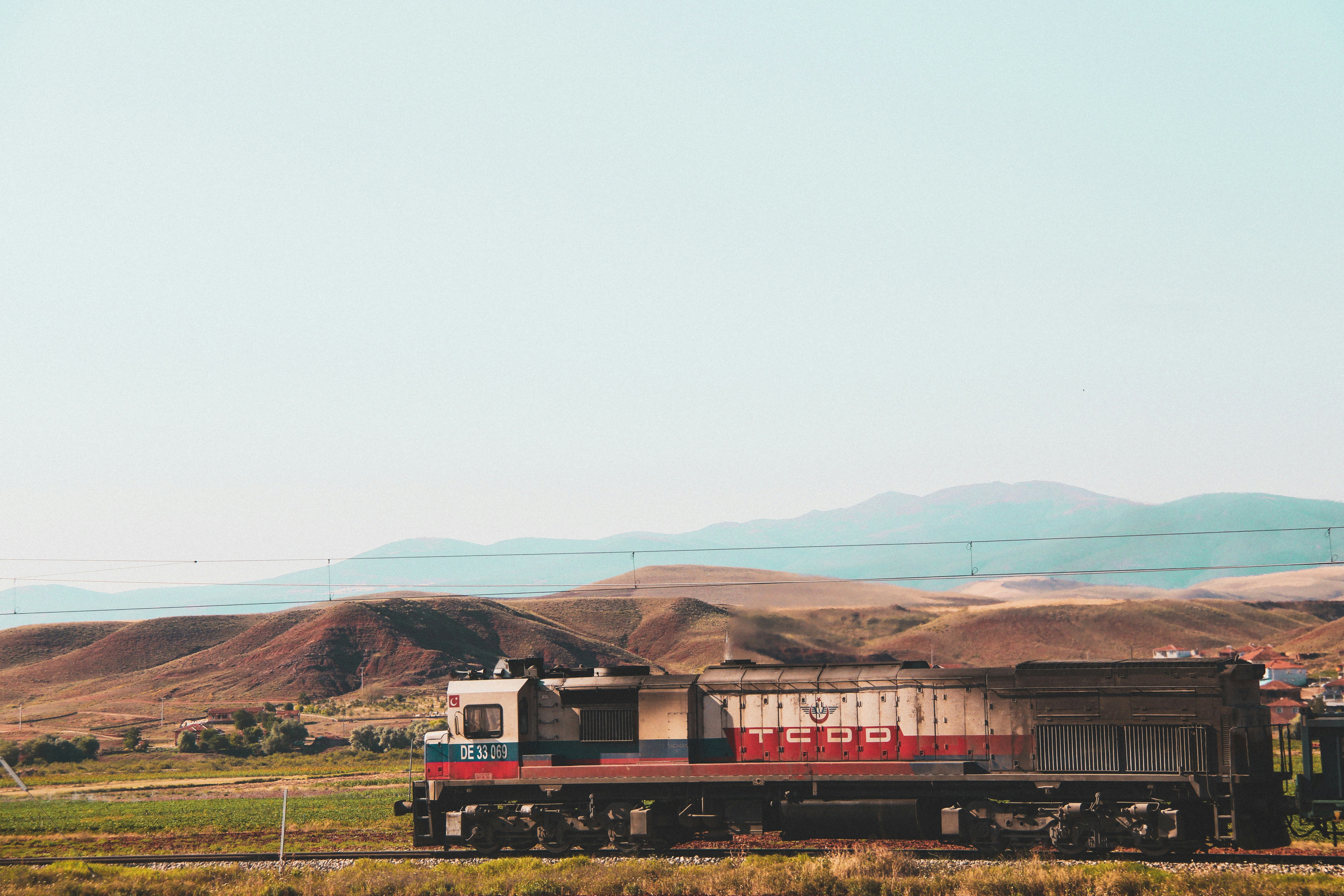Lonely Tracks: A Freight Engine Looms Over Desert Plains