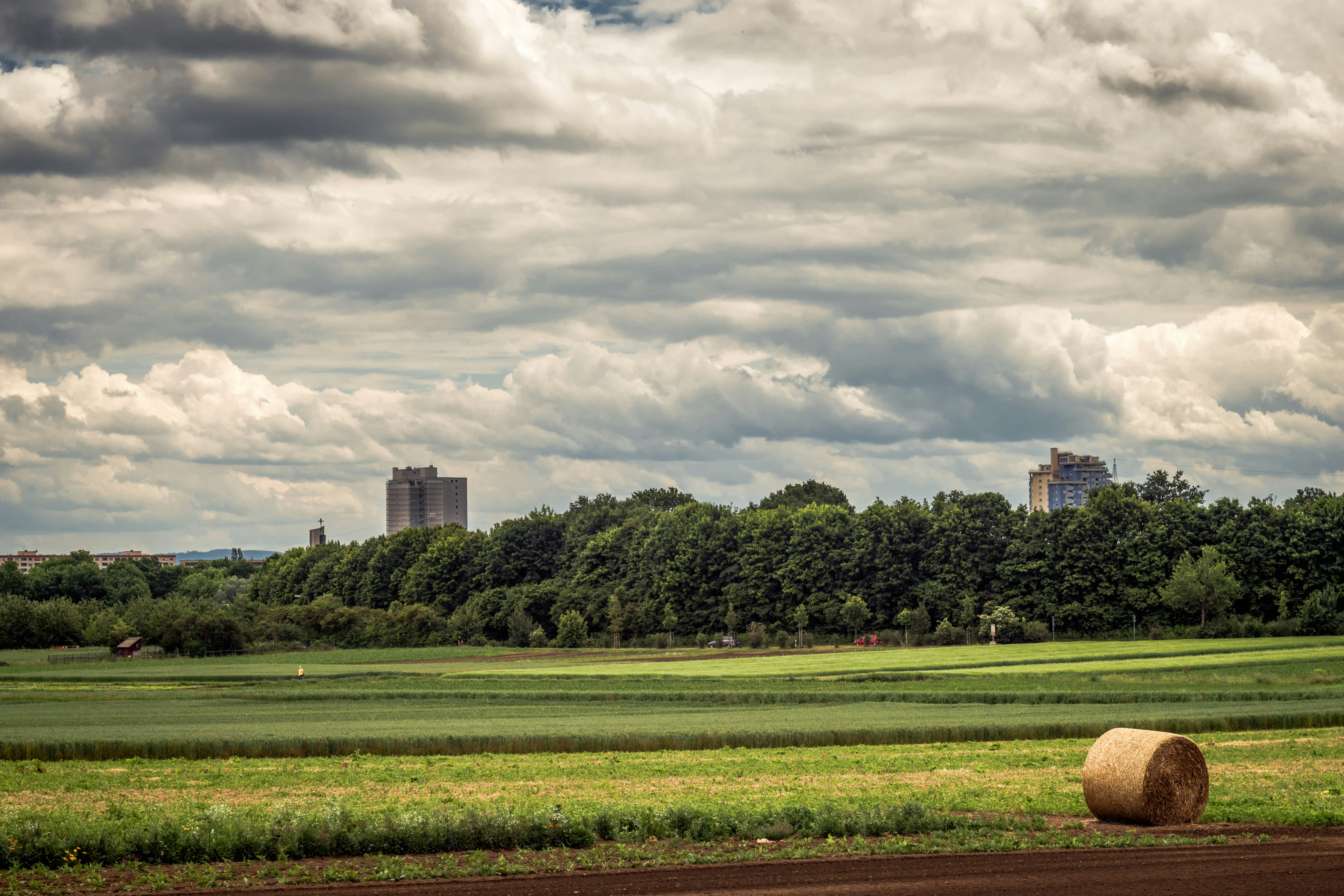 Hay Bale Anchor: A Quiet Rural Panorama Under a Brooding Sky