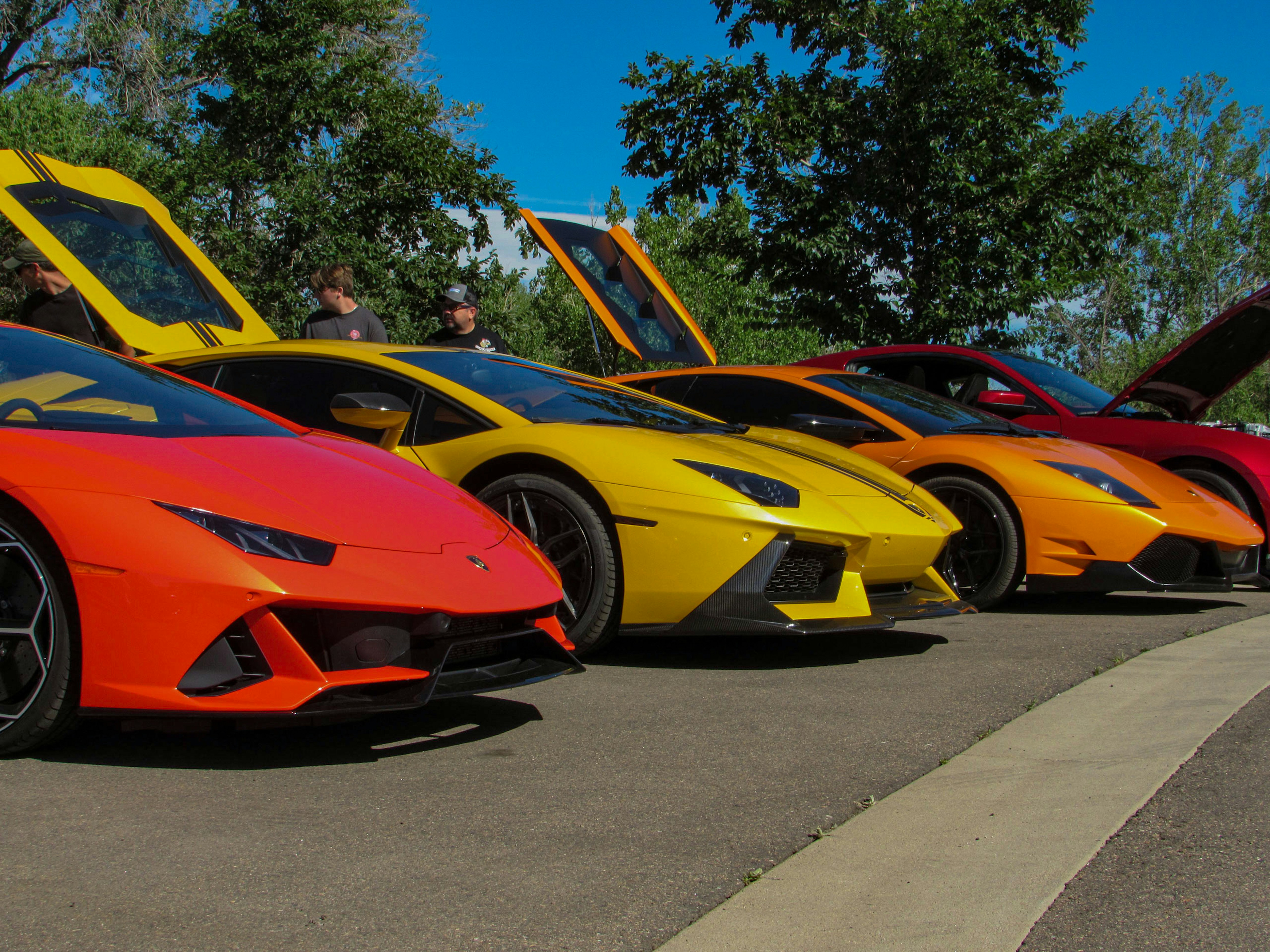 A group of sports cars parked photo – Free Person Image on Unsplash