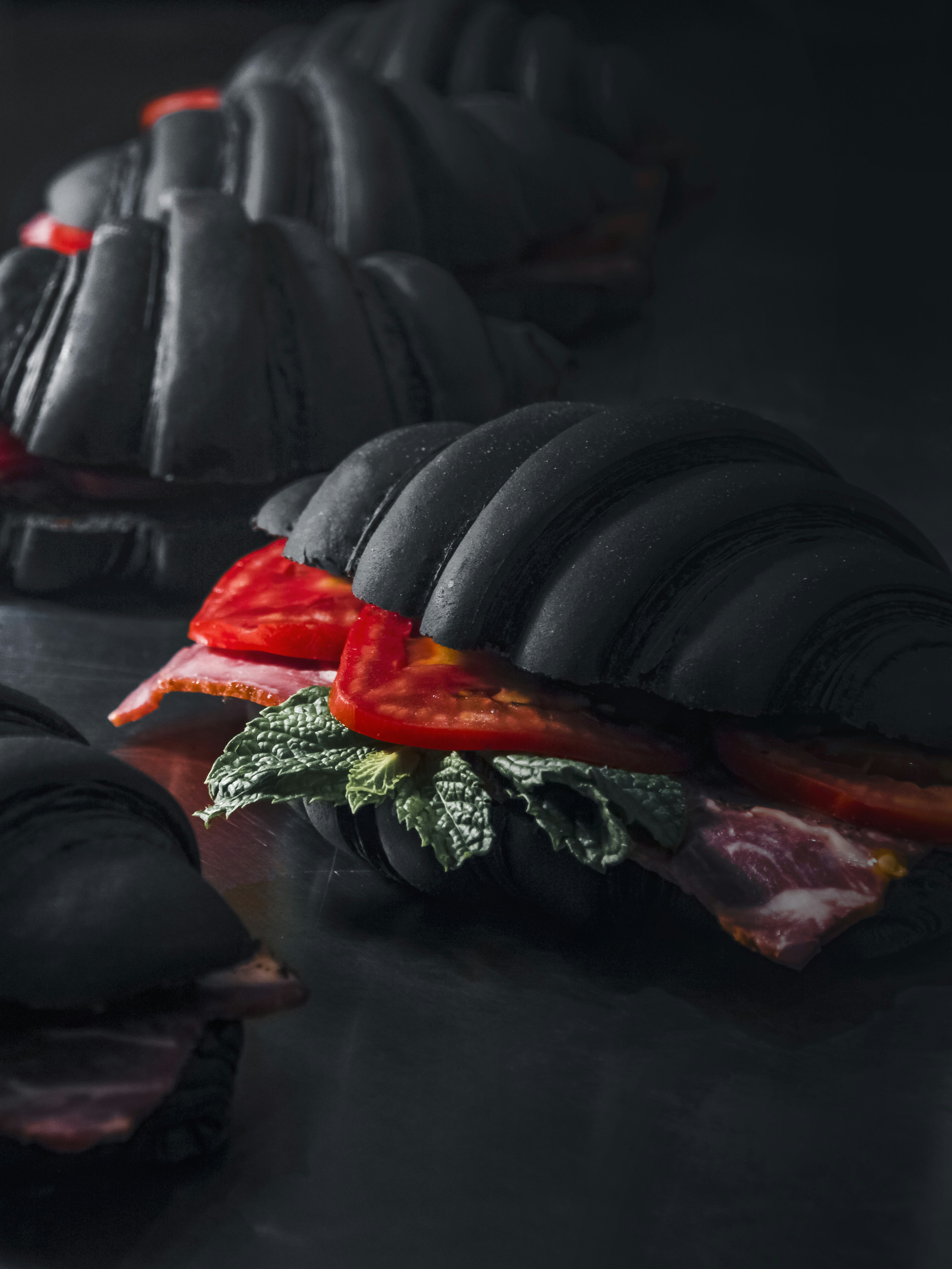 Midnight Buns: Charcoal Bread, Tomato Slices, and Mint in a Moody Sandwich Still Life