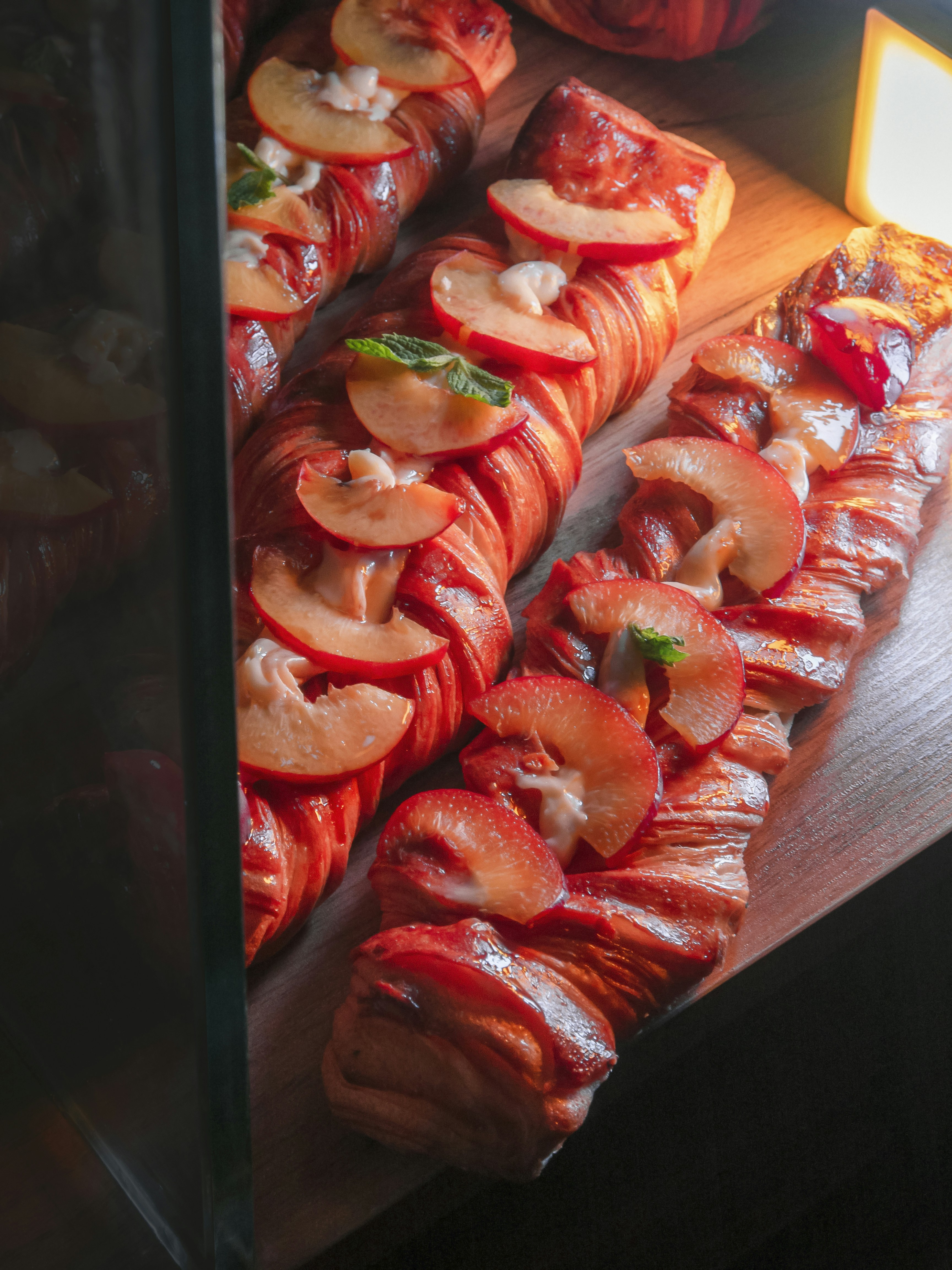 Amber Skewers: Apple-topped Meat Spirals in a Wood Display