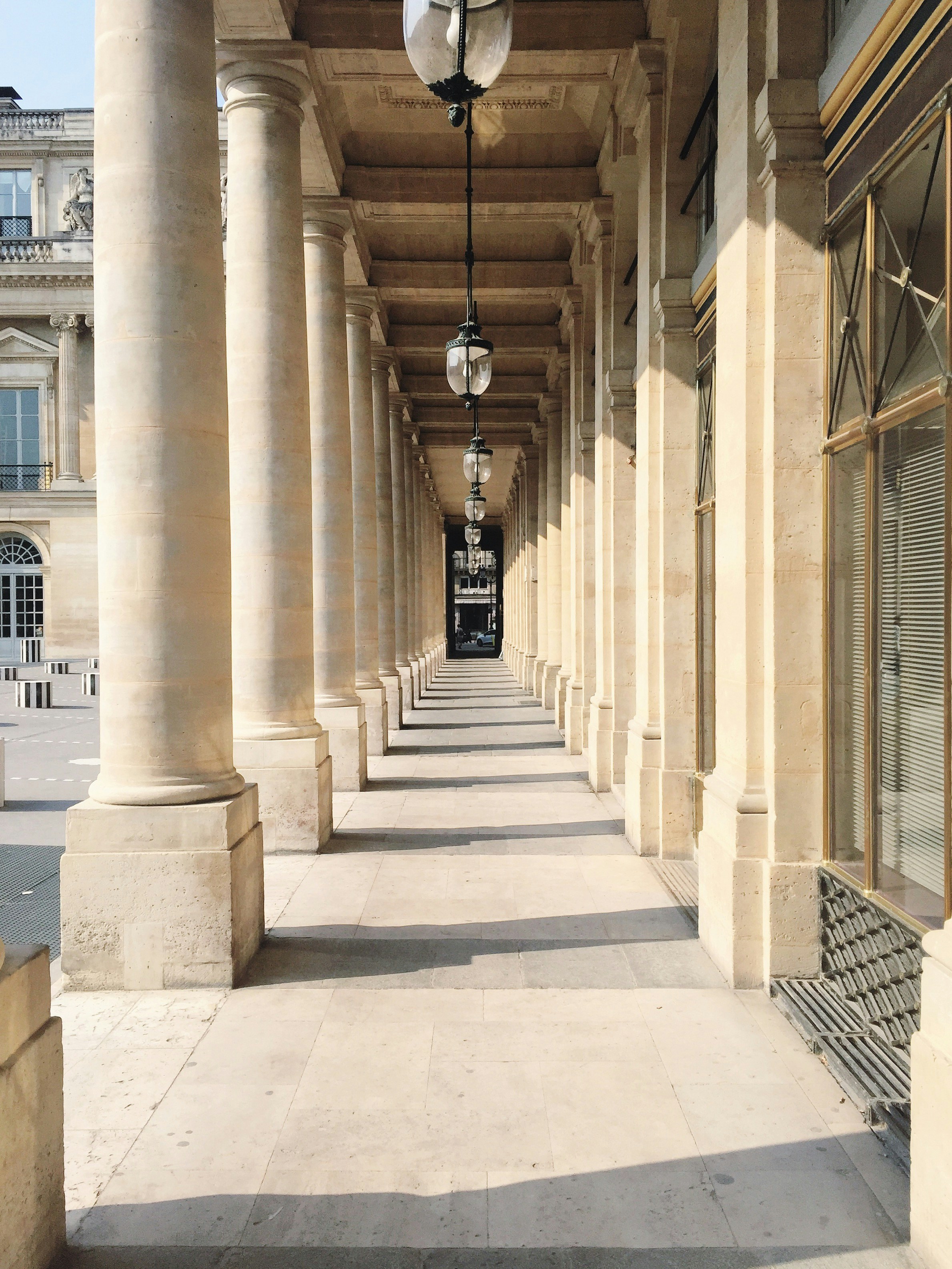 Colonnade Echoes: A Long Corridor of Light and Shadow