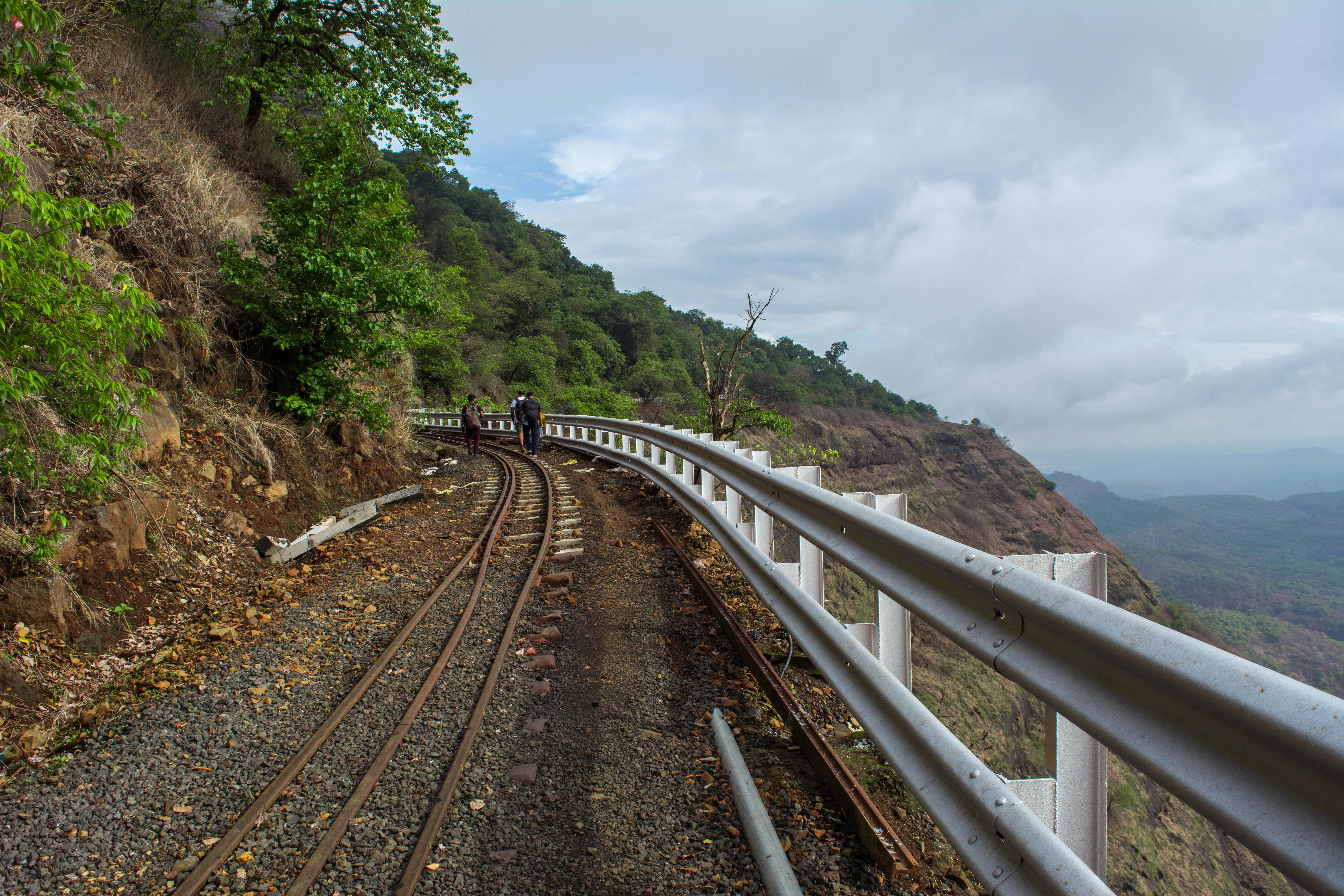 Curve on the Cliff: Hikers Pause on the Gorge Rail