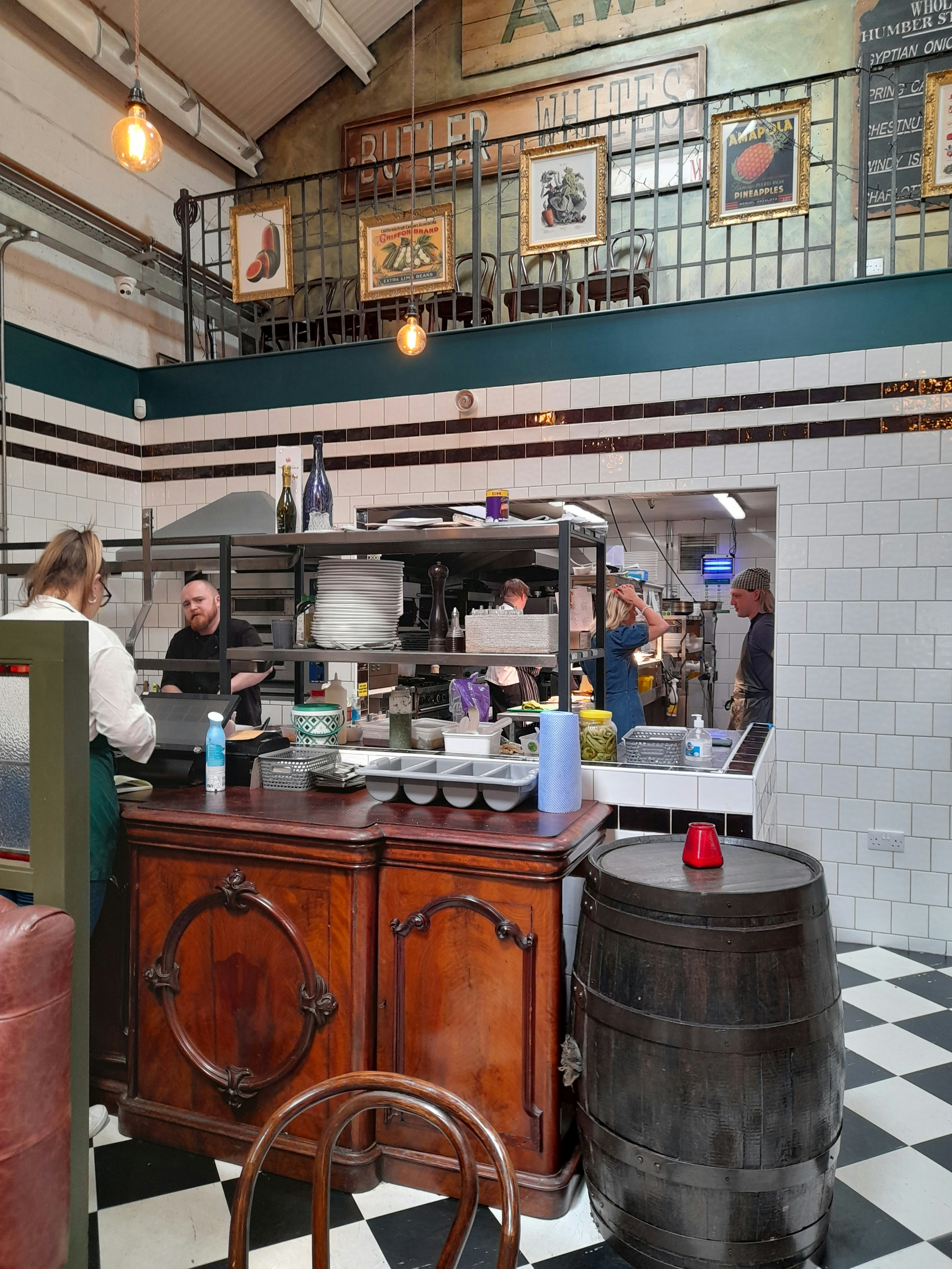 Open Kitchen at Diner with Antique Cabinet and Barrel