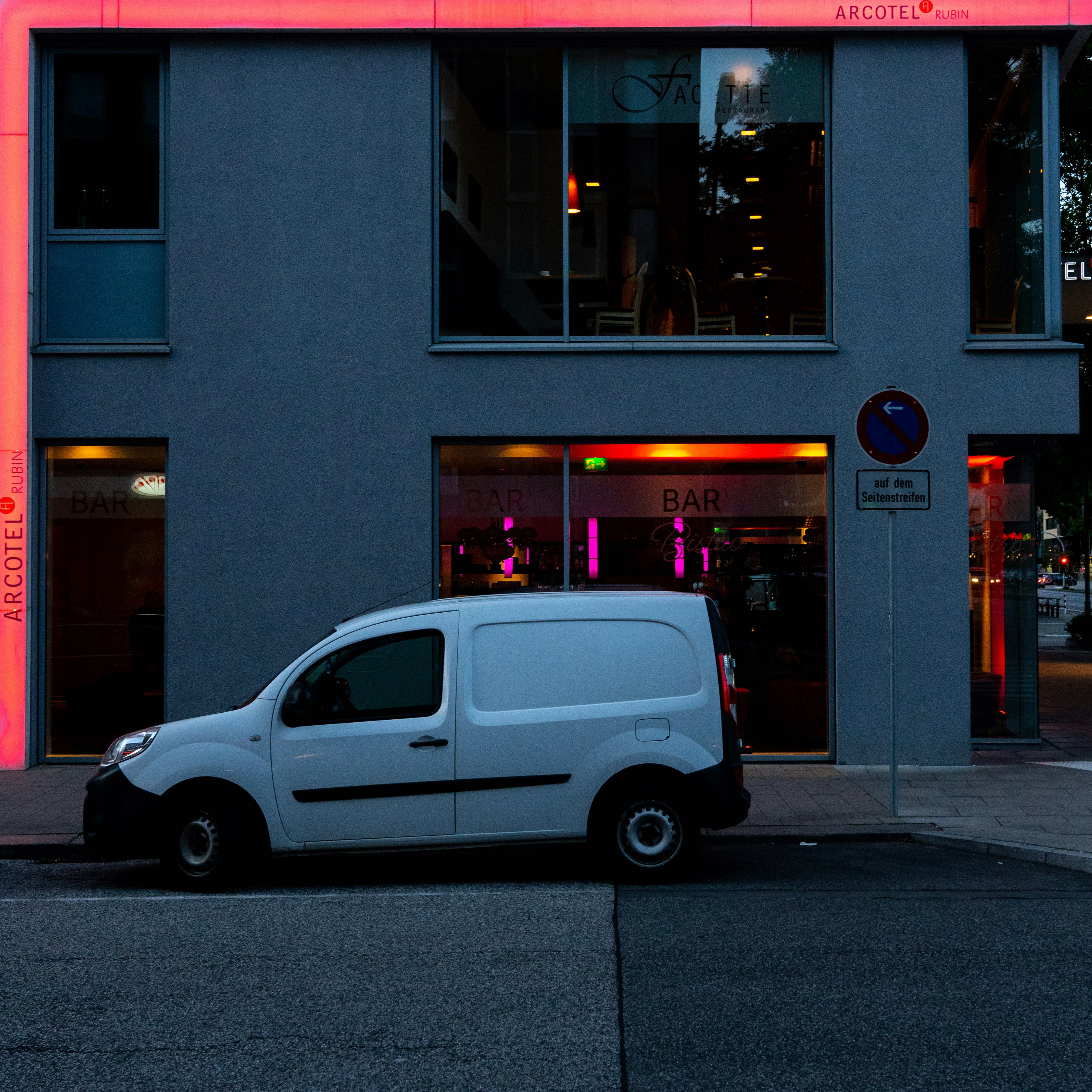 A white van parked outside a building photo – Free Light Image on Unsplash