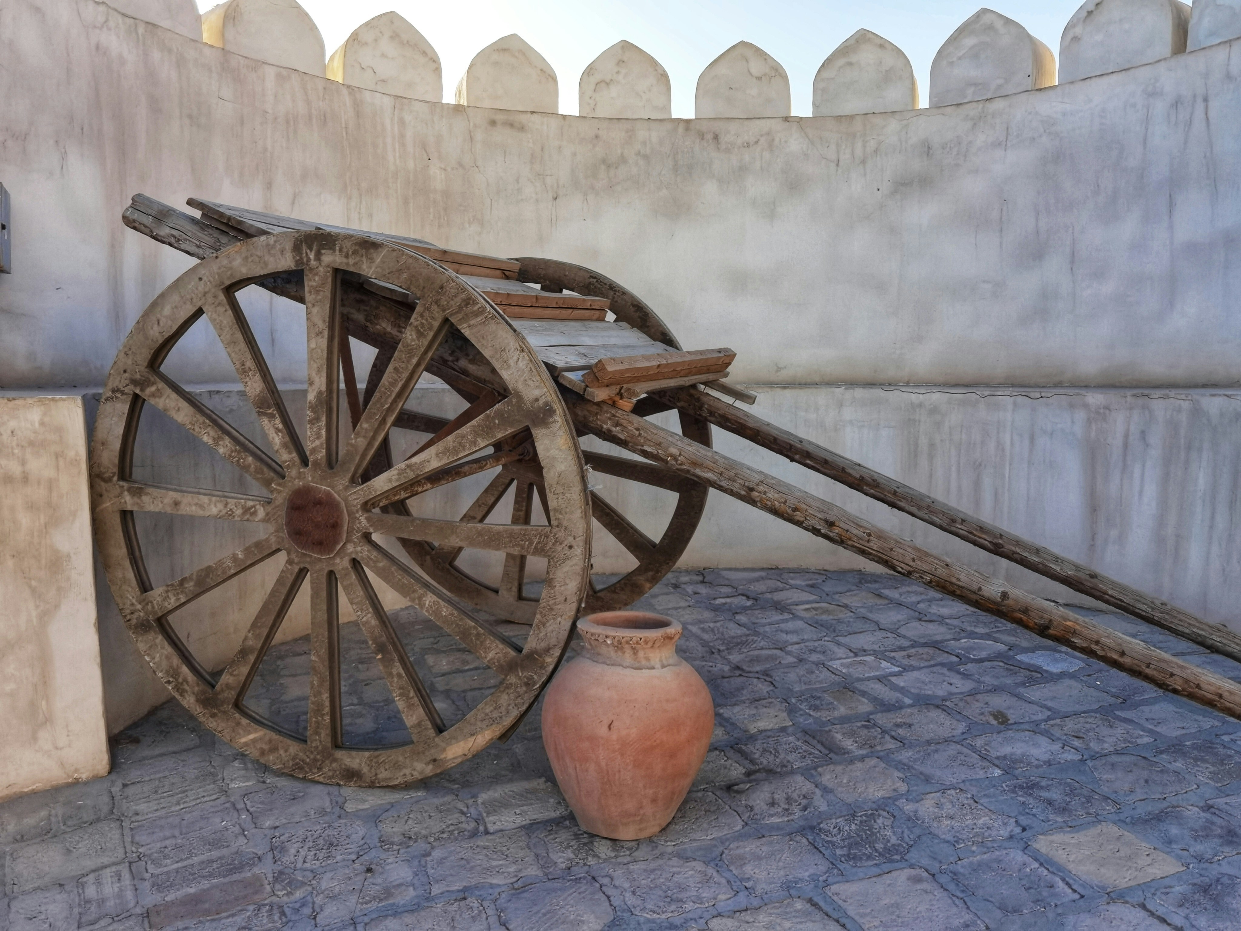 a wooden wheel on a brick surface