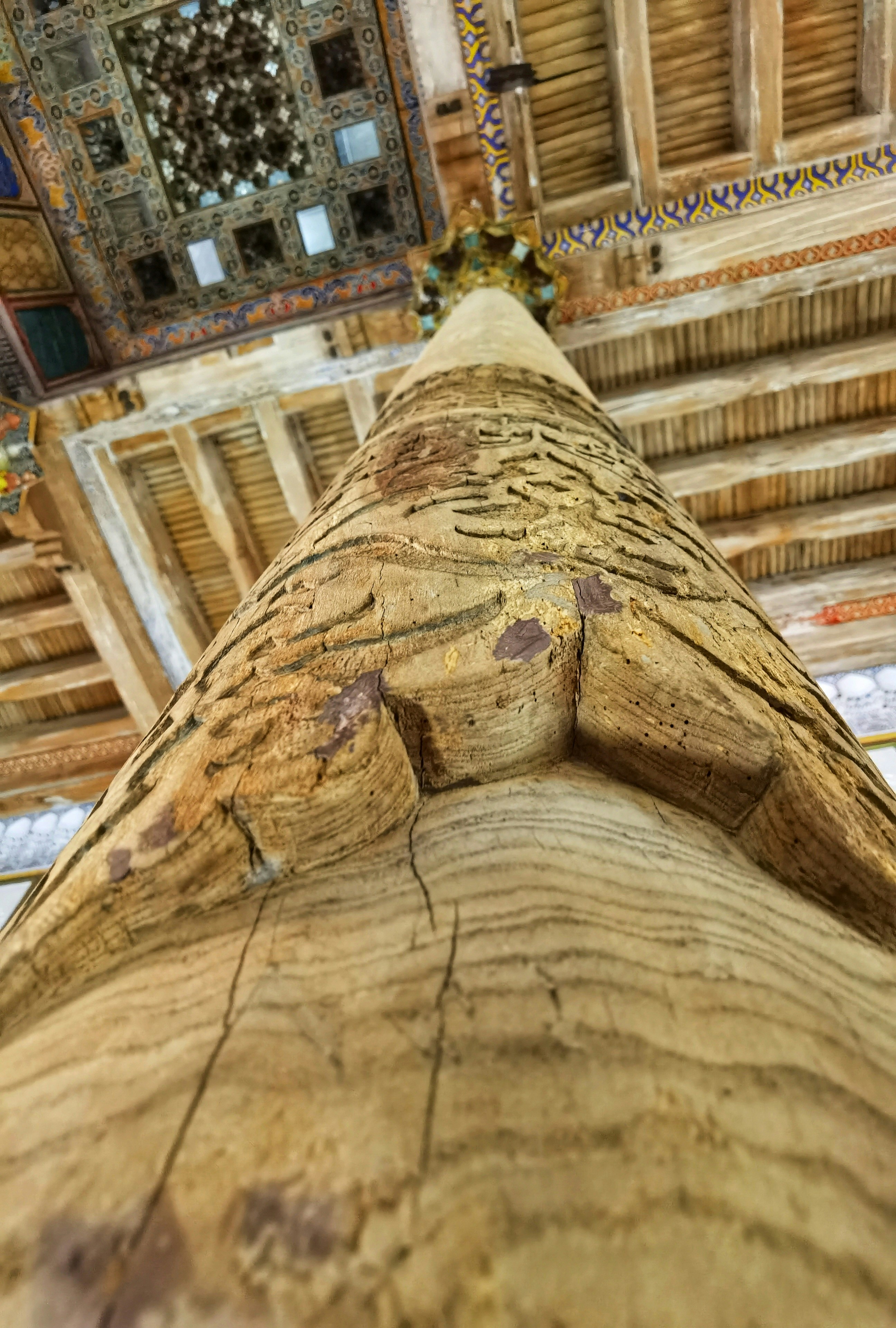 Carved Timber Ascends Toward a Mosaic Ceiling