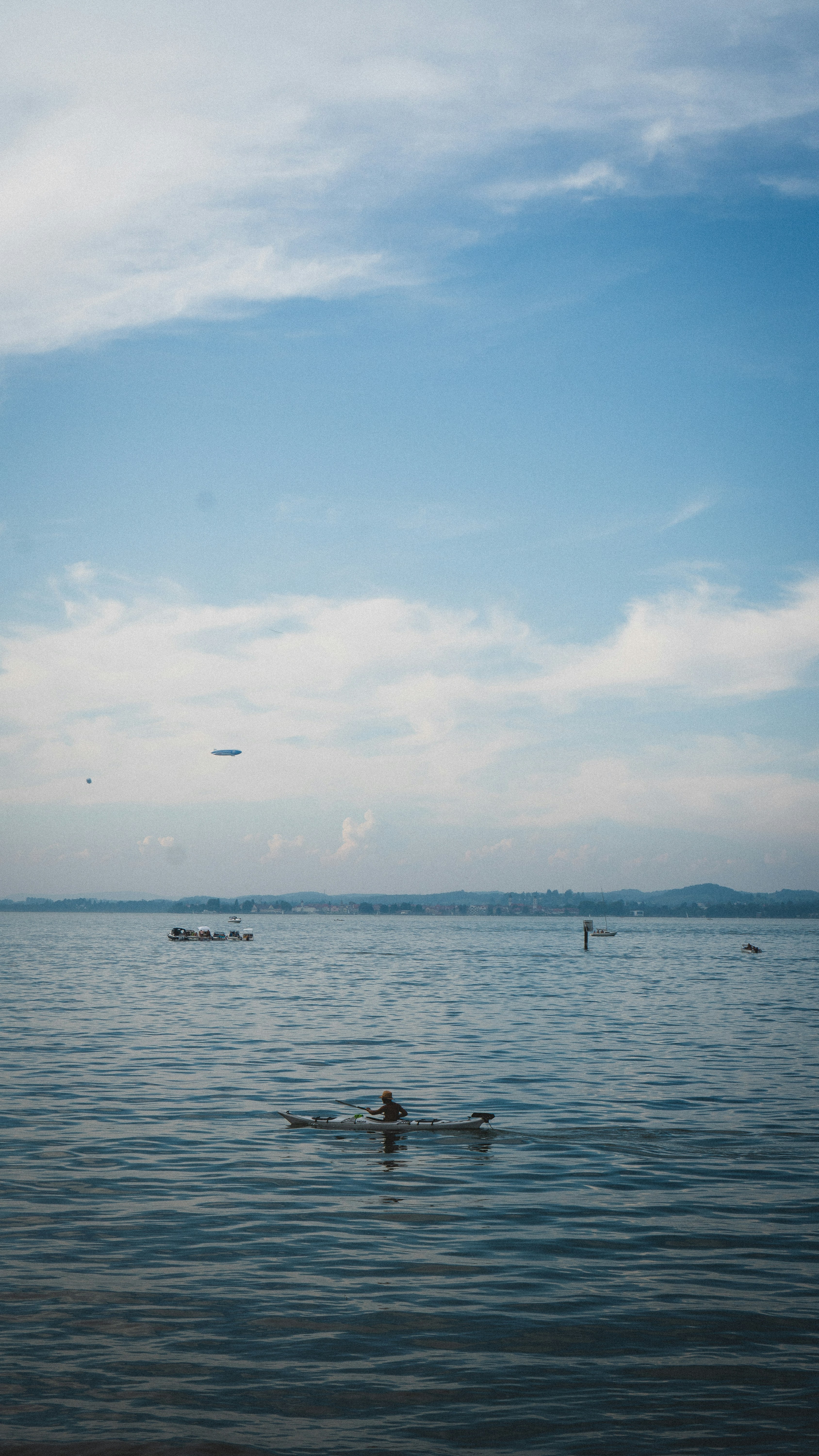 Quiet Glide Across a Vast Lake Under a Wide Sky