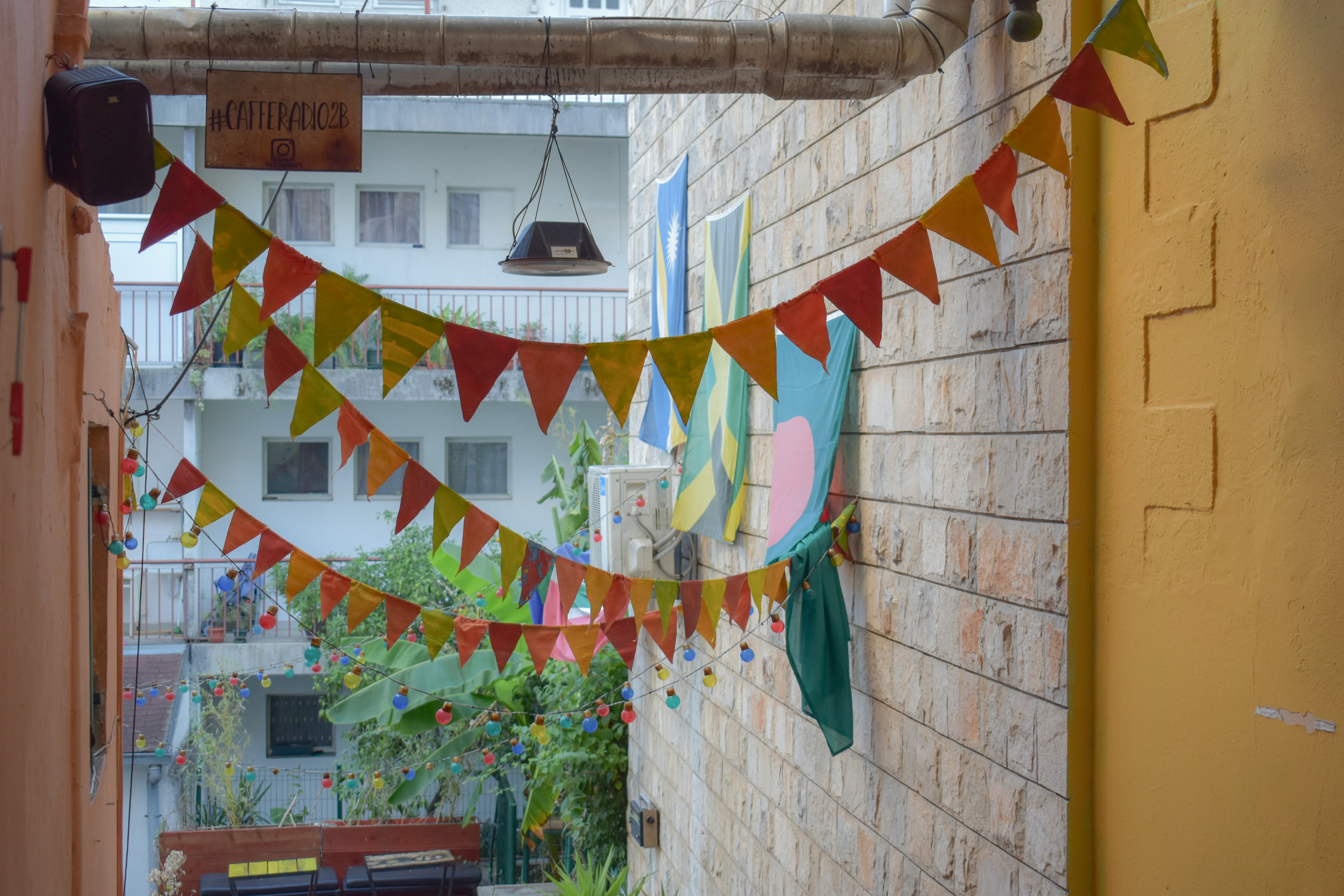 Colorful Bunting Over a Sunlit Alley