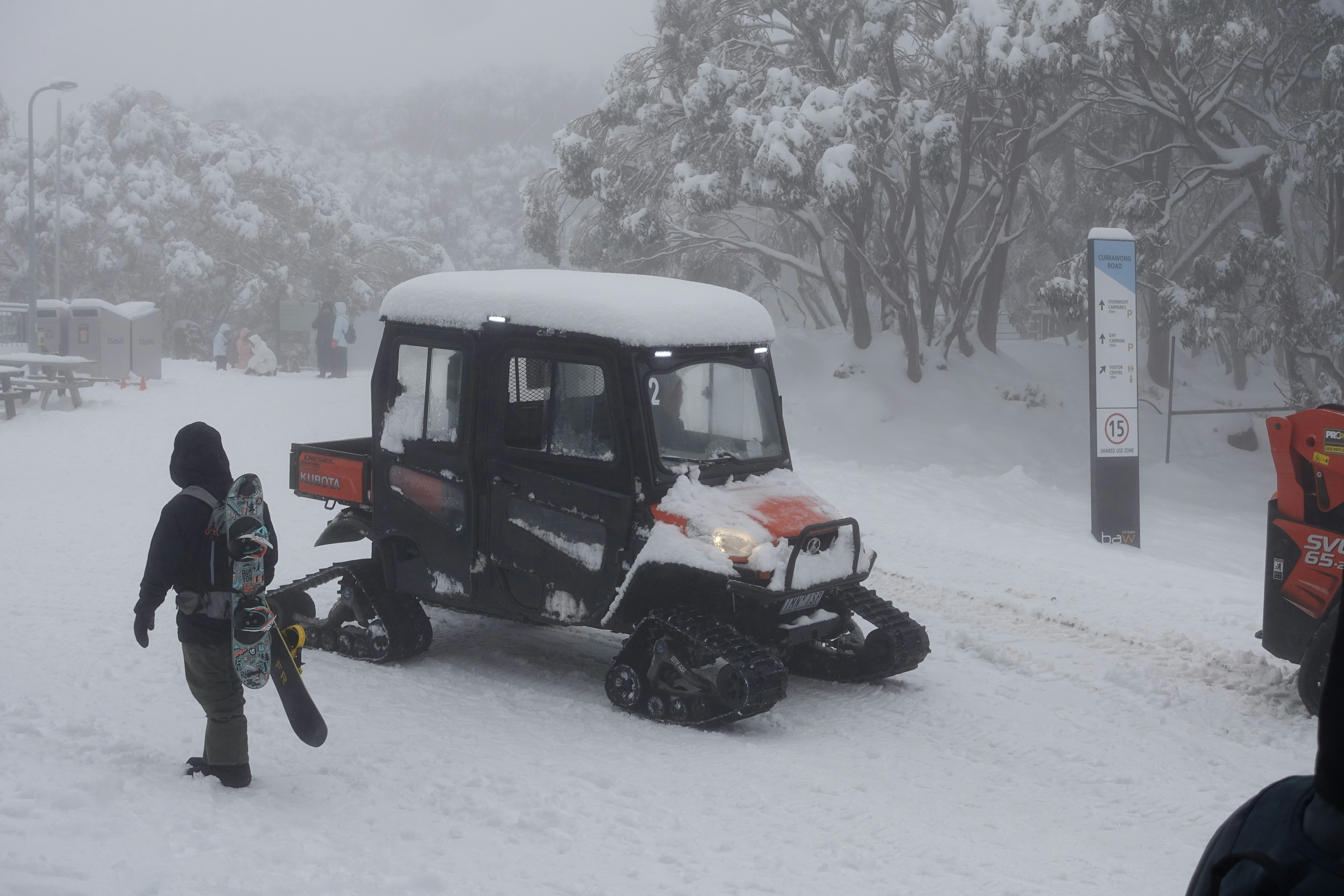 Snowbound Rescue: A Snowcat Ready at the Park in Heavy Flurries