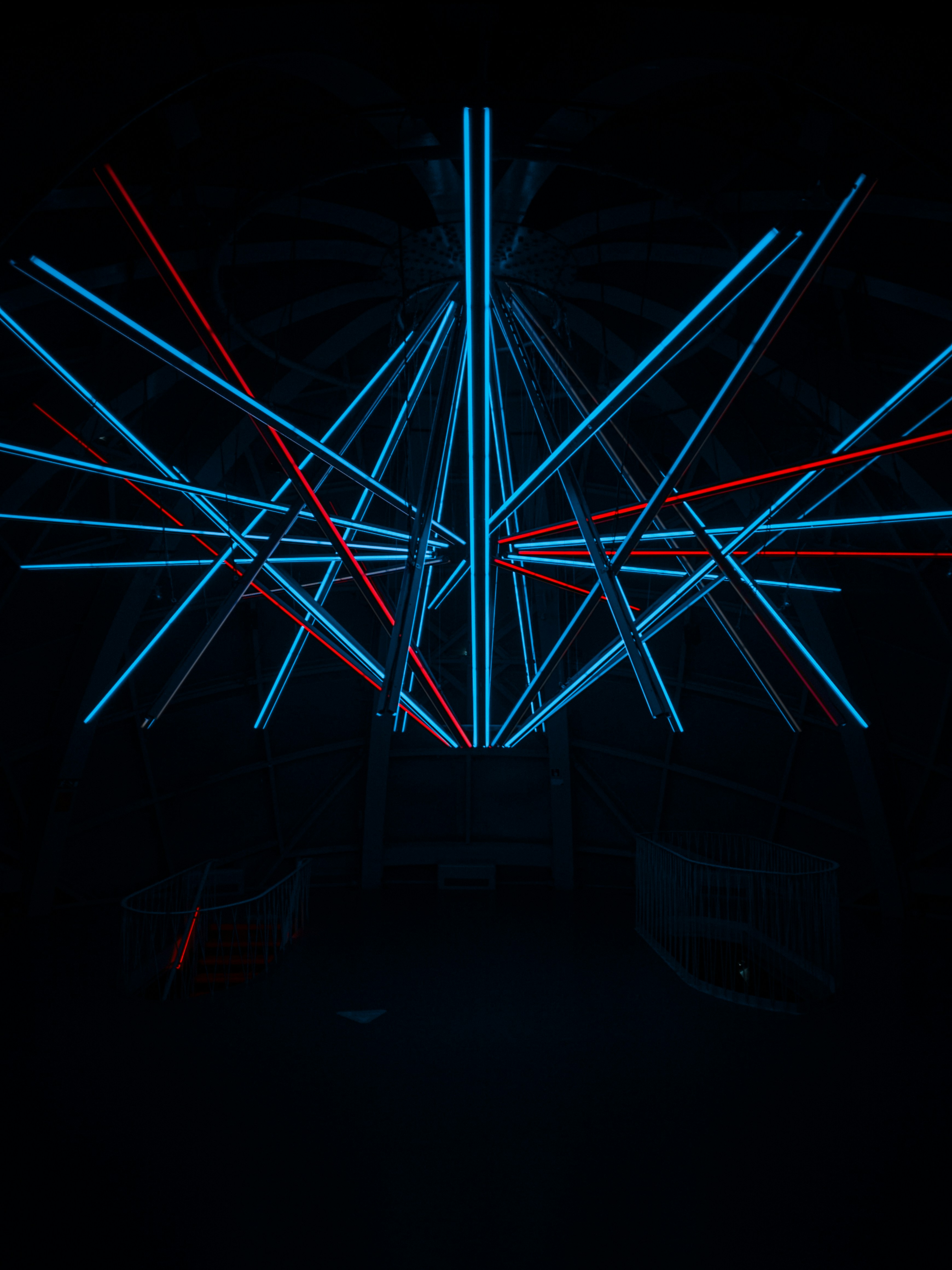 Blue Neon Lattice Convergence in a Dark Atrium