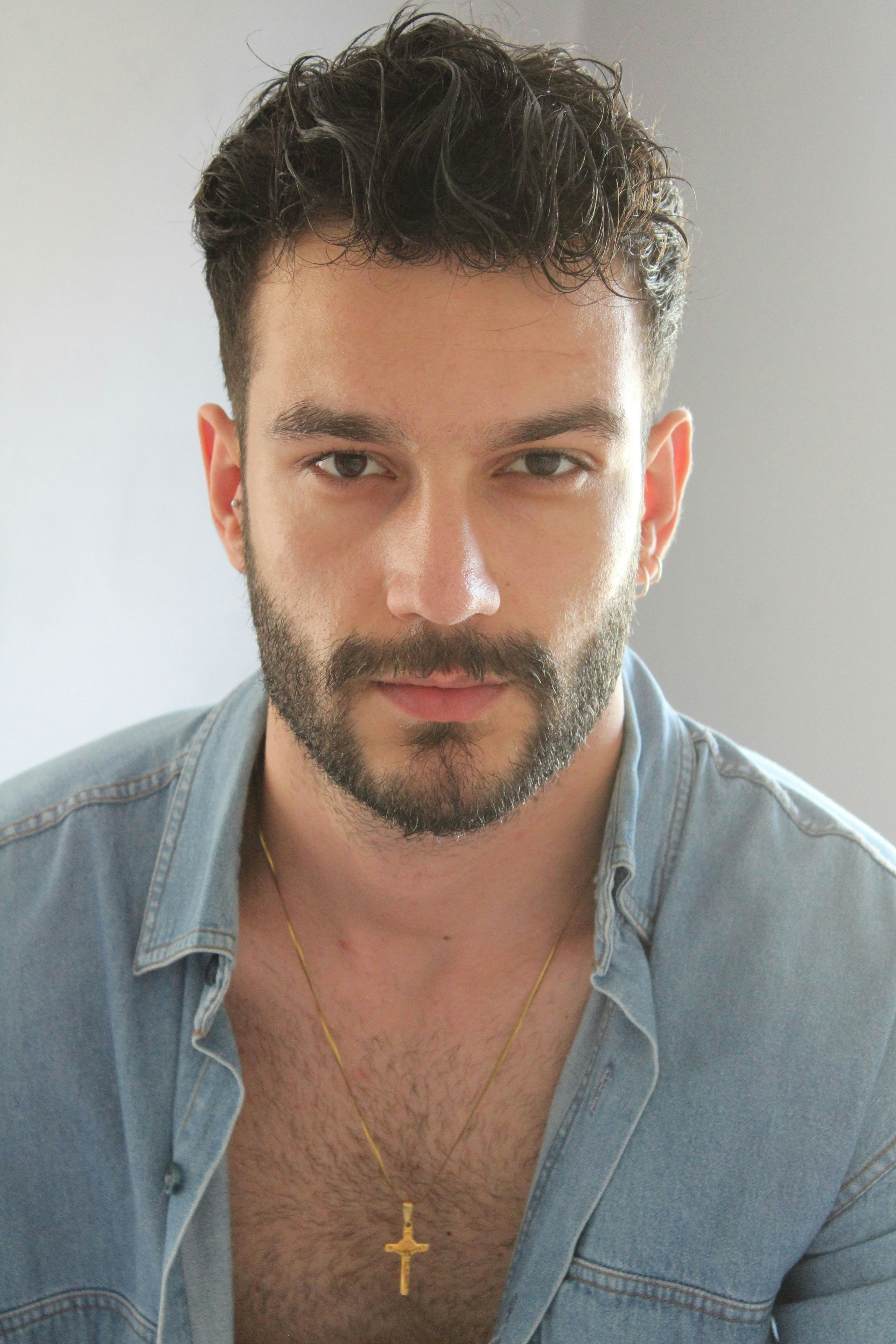 Centered Gaze Under Soft Light: Portrait of a Man in Denim