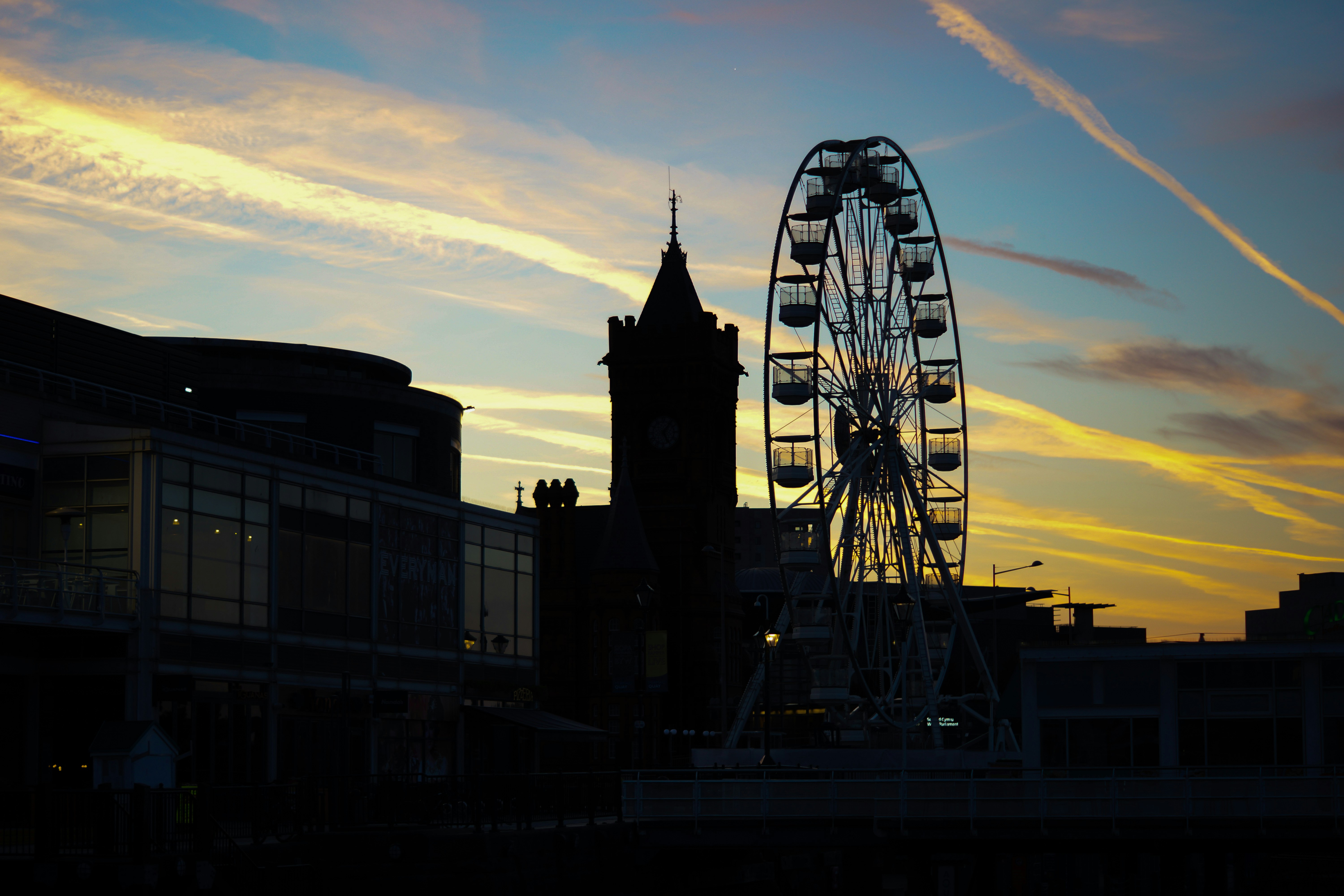 A ferris wheel in front of a building photo – Free Cardiff bay Image on ...