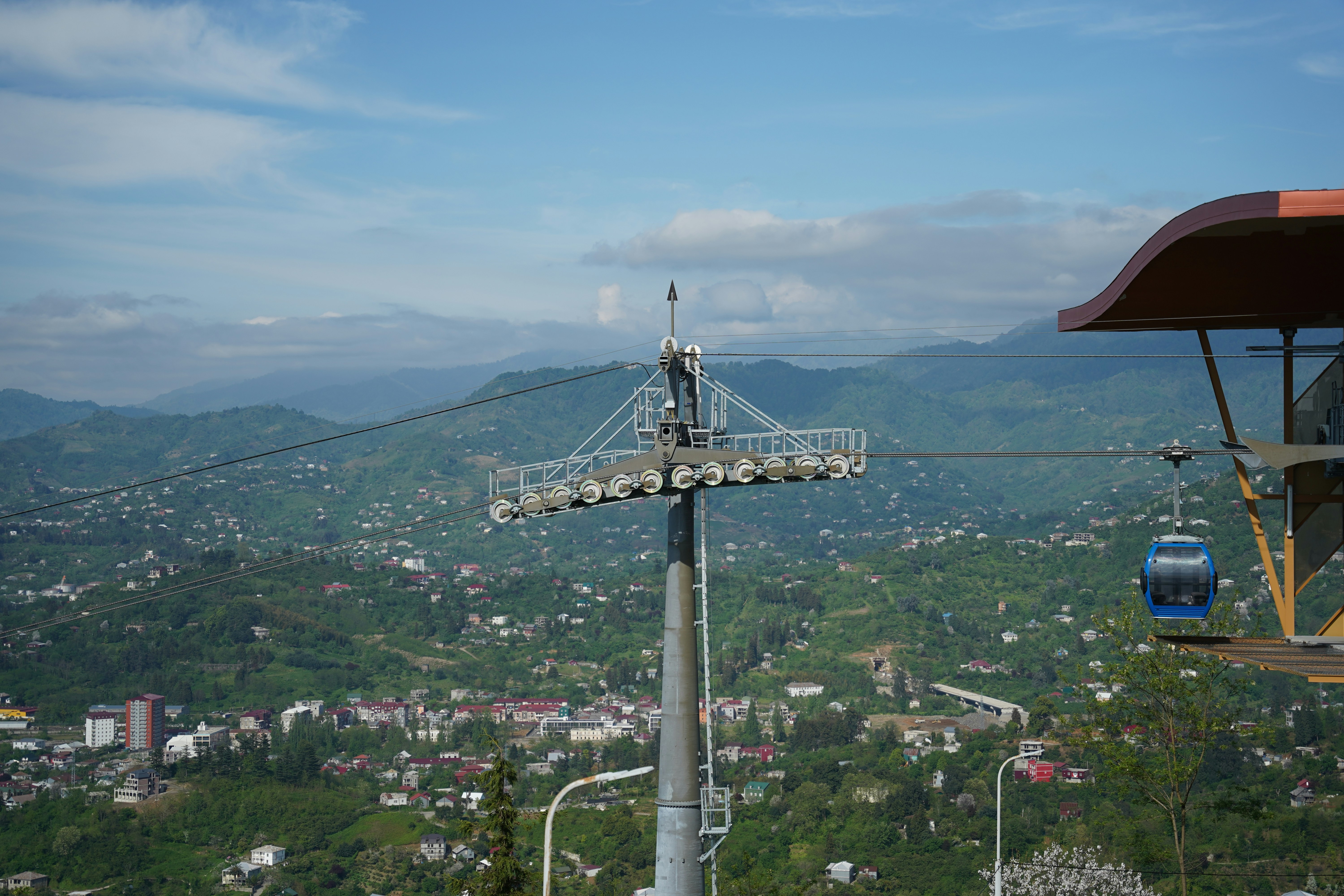 Cable Car Over a Verdant Valley: A Panoramic Summit View