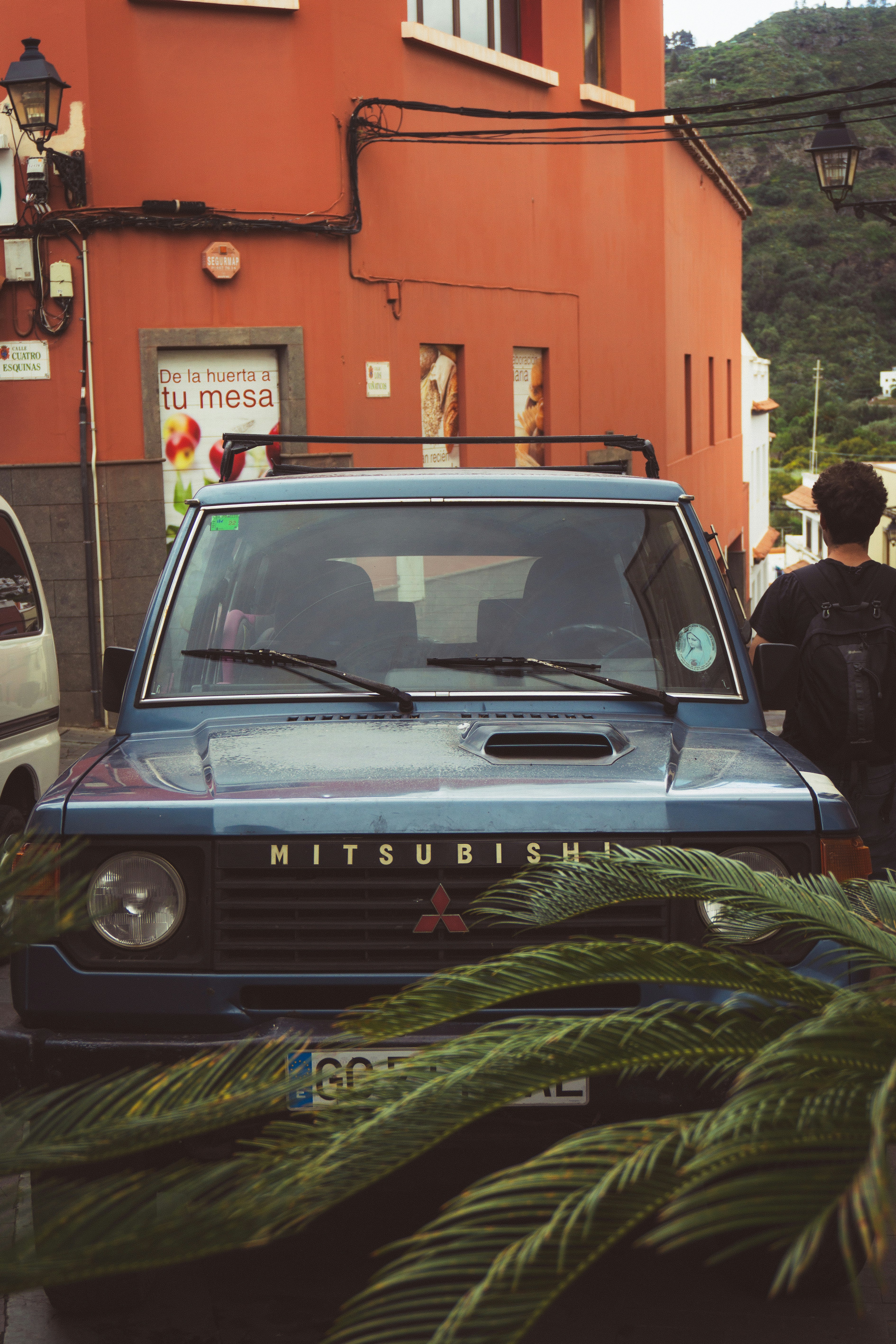 Blue Mitsubishi Pickup Anchored by Orange Facade