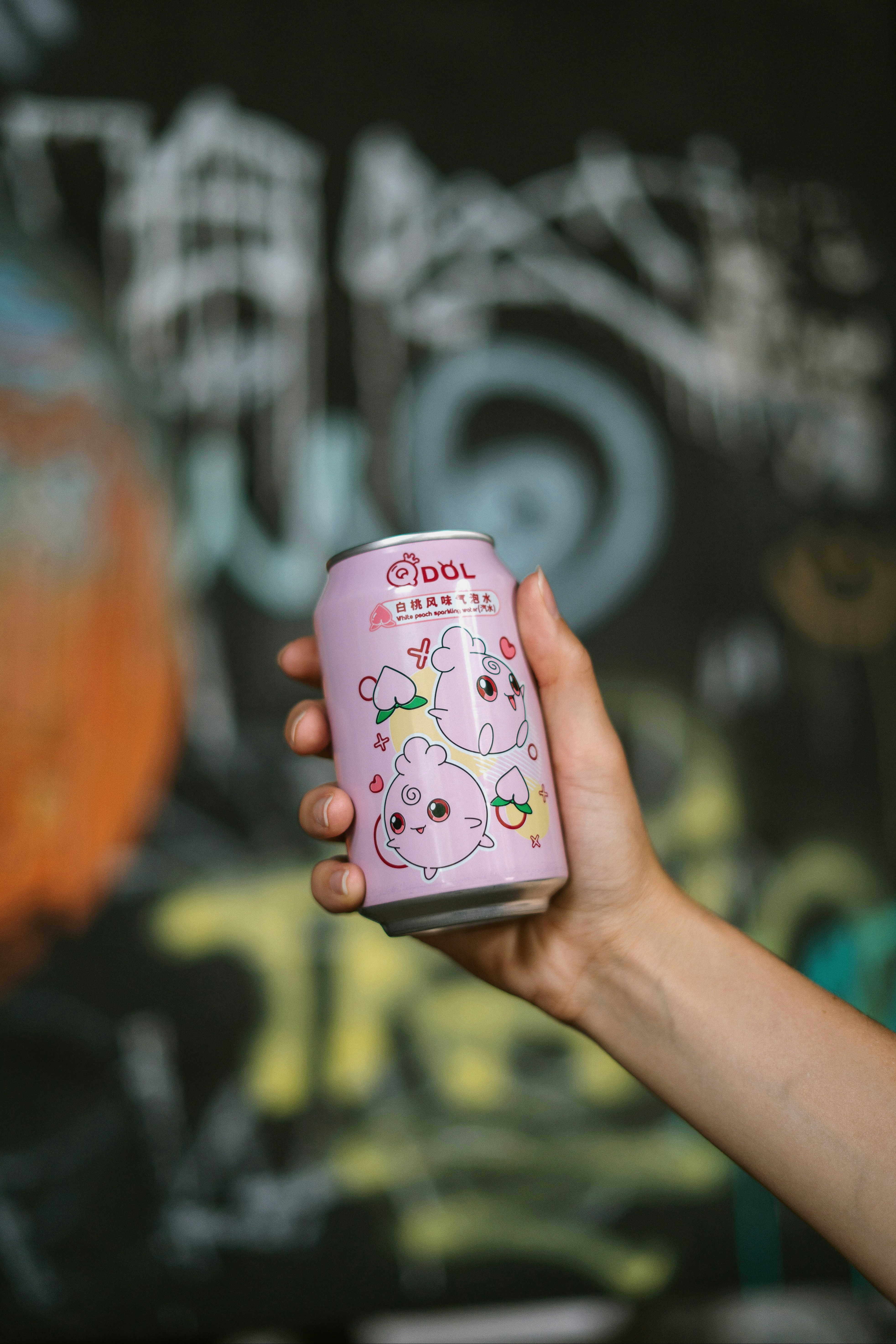 Pastel Cartoon Can in Hand, Against a Graffiti Backdrop