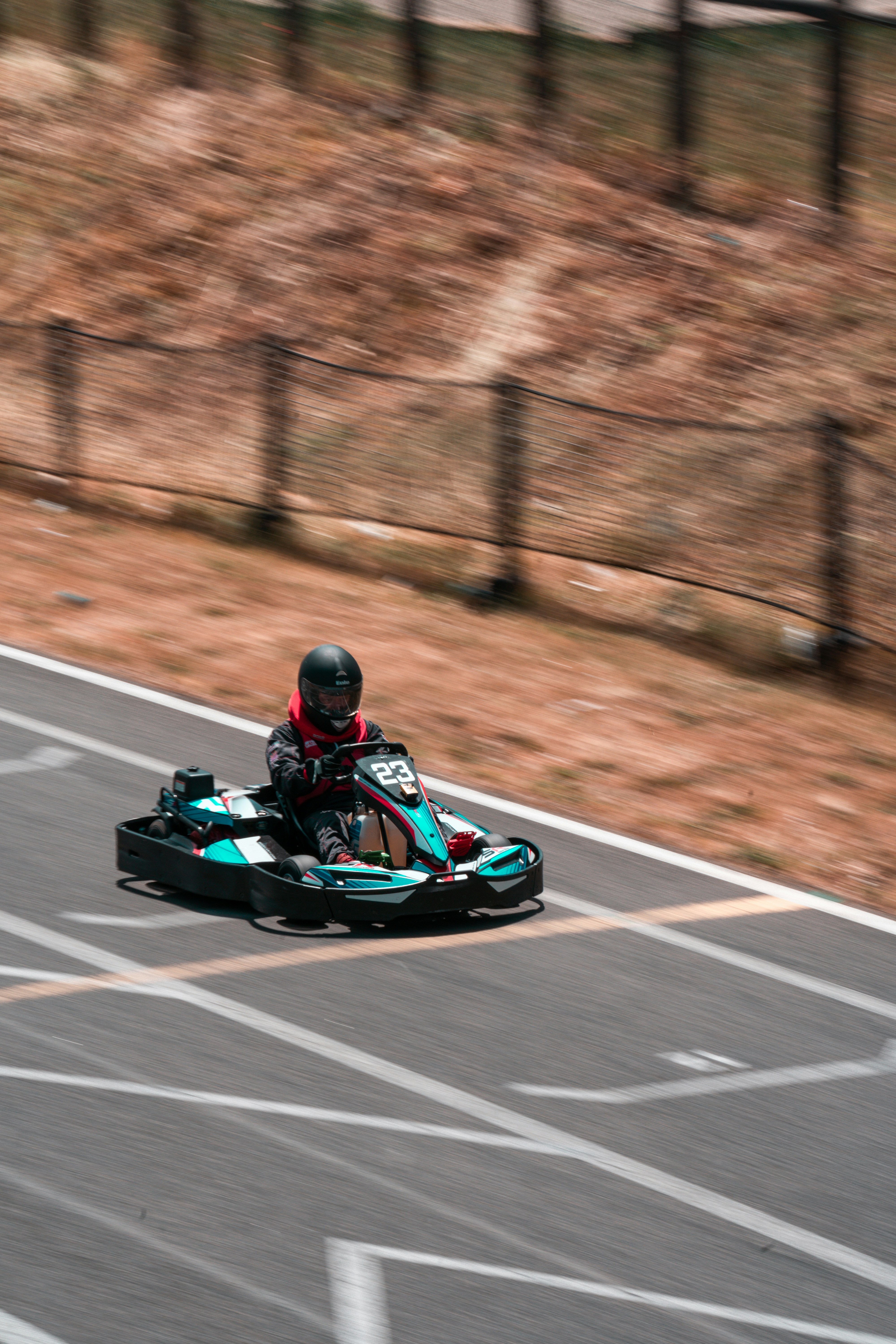 A person driving a go kart on a road photo – Free Grey Image on Unsplash