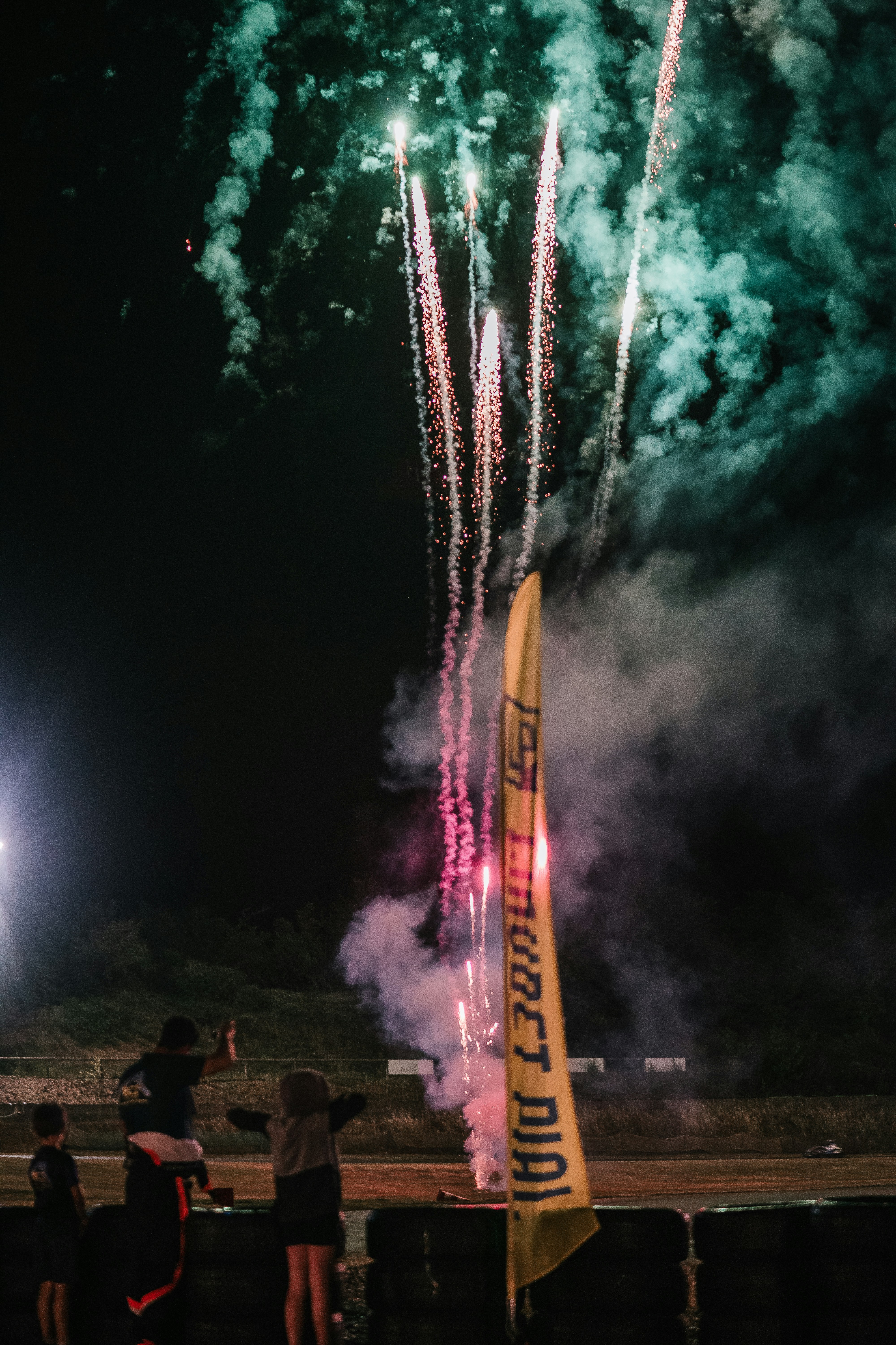 A rocket launching with fireworks in the background photo – Free Person ...