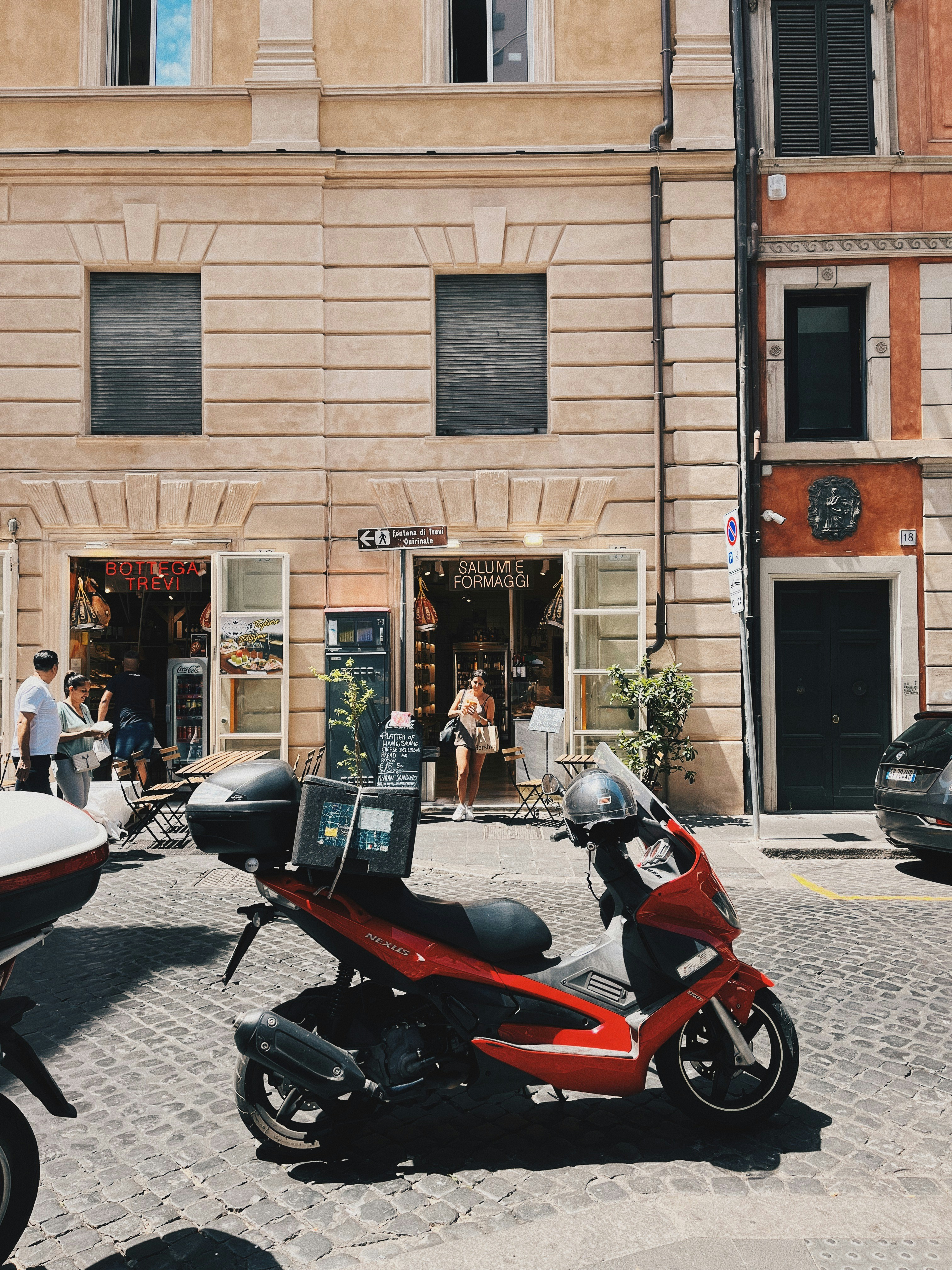 Crimson Scooter Corner on a Sunlit Italian Street