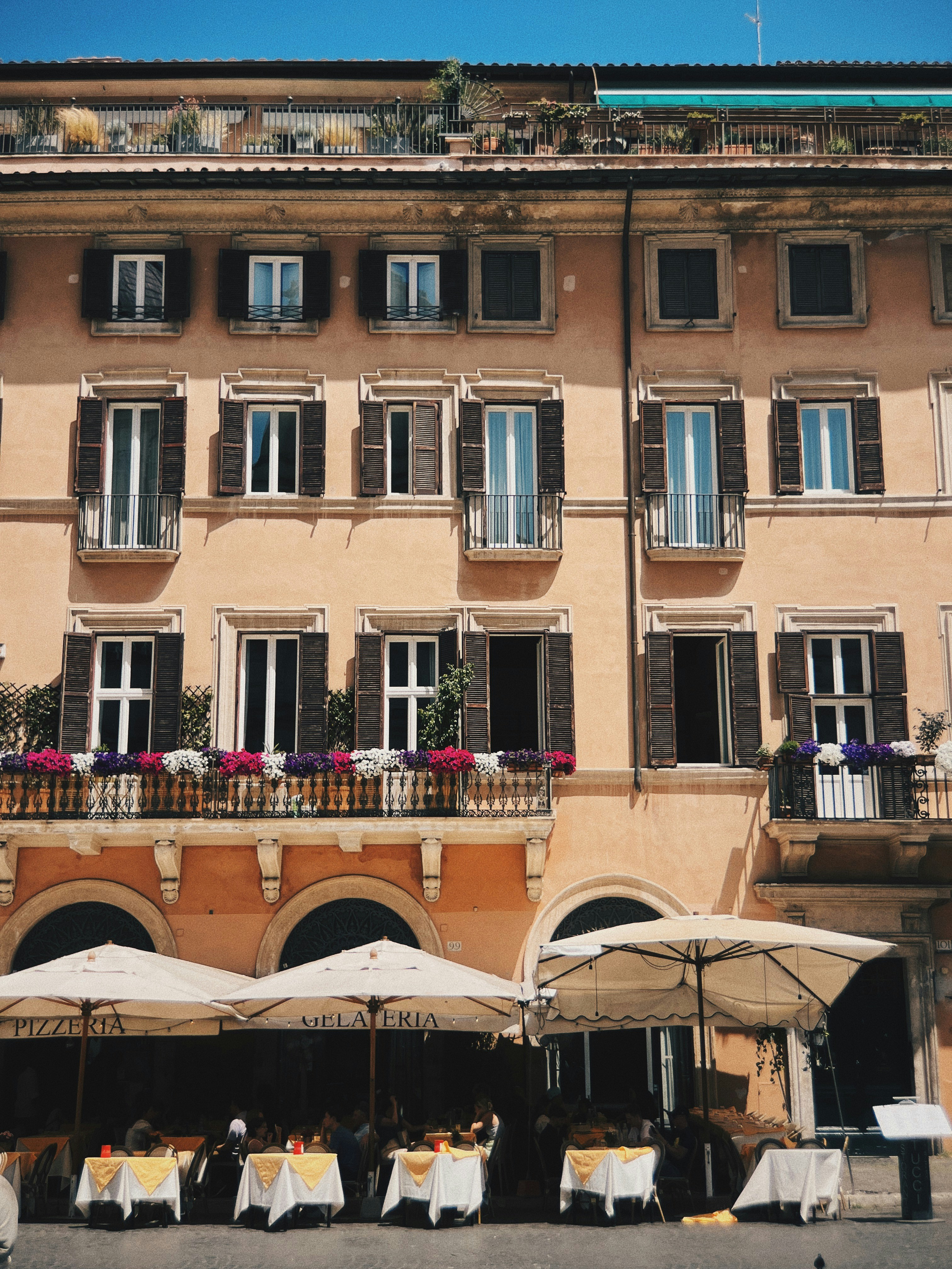 Sunlit Facade with Courtyard Café under Archways