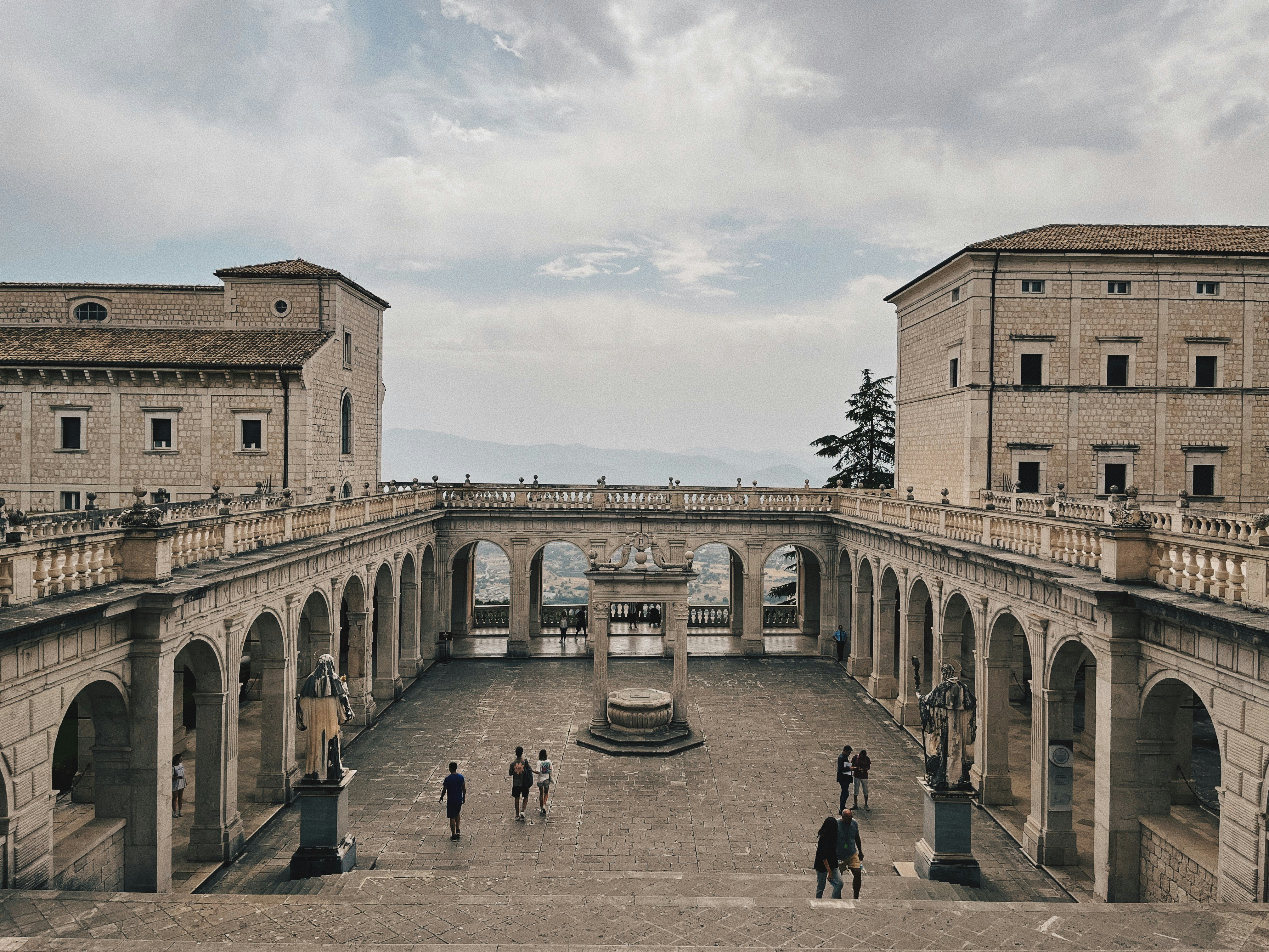 a large stone courtyard with a bridge