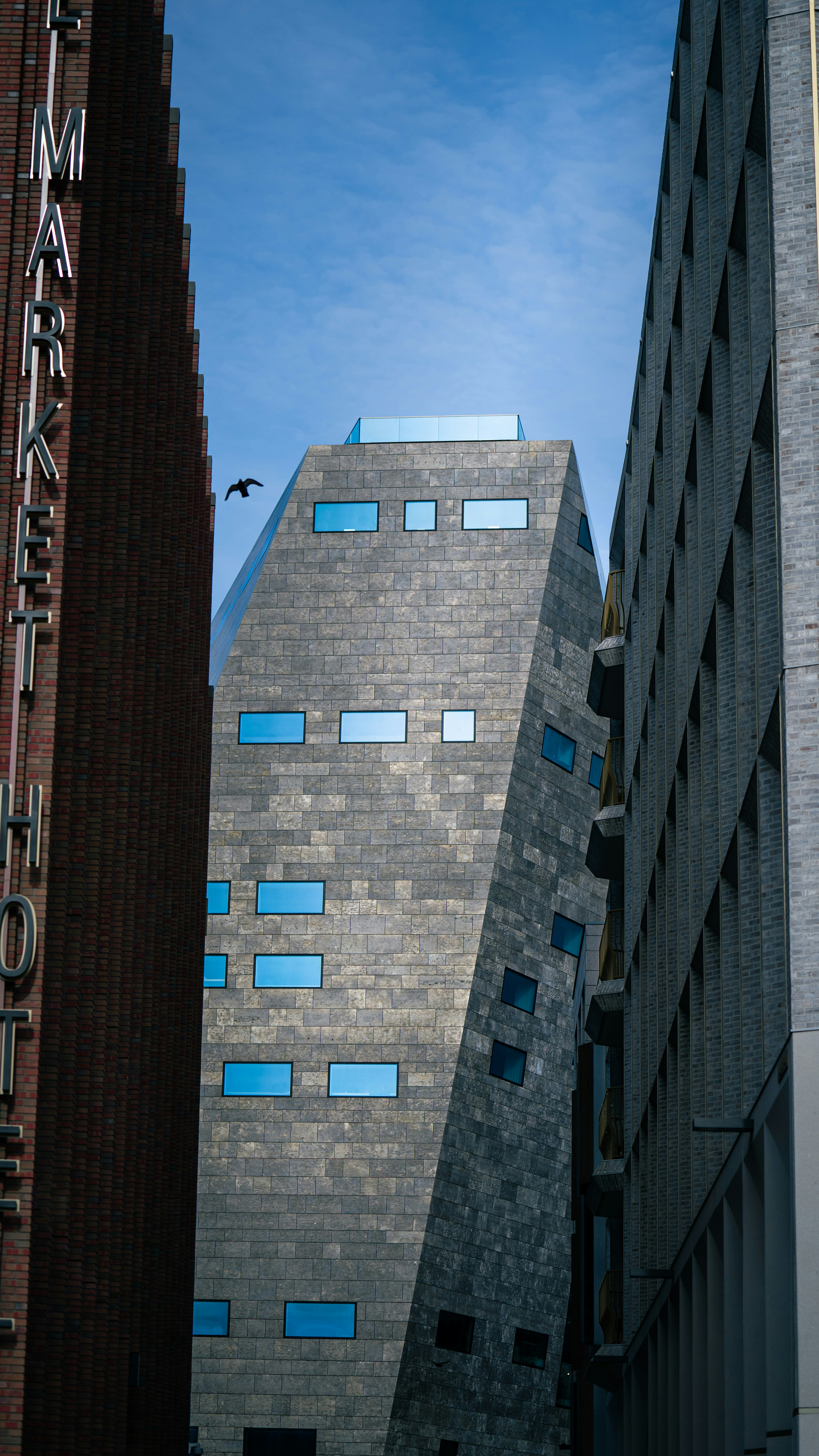 Canopy of Angles: A Narrow Urban Rift Between Brick, Stone and Sky
