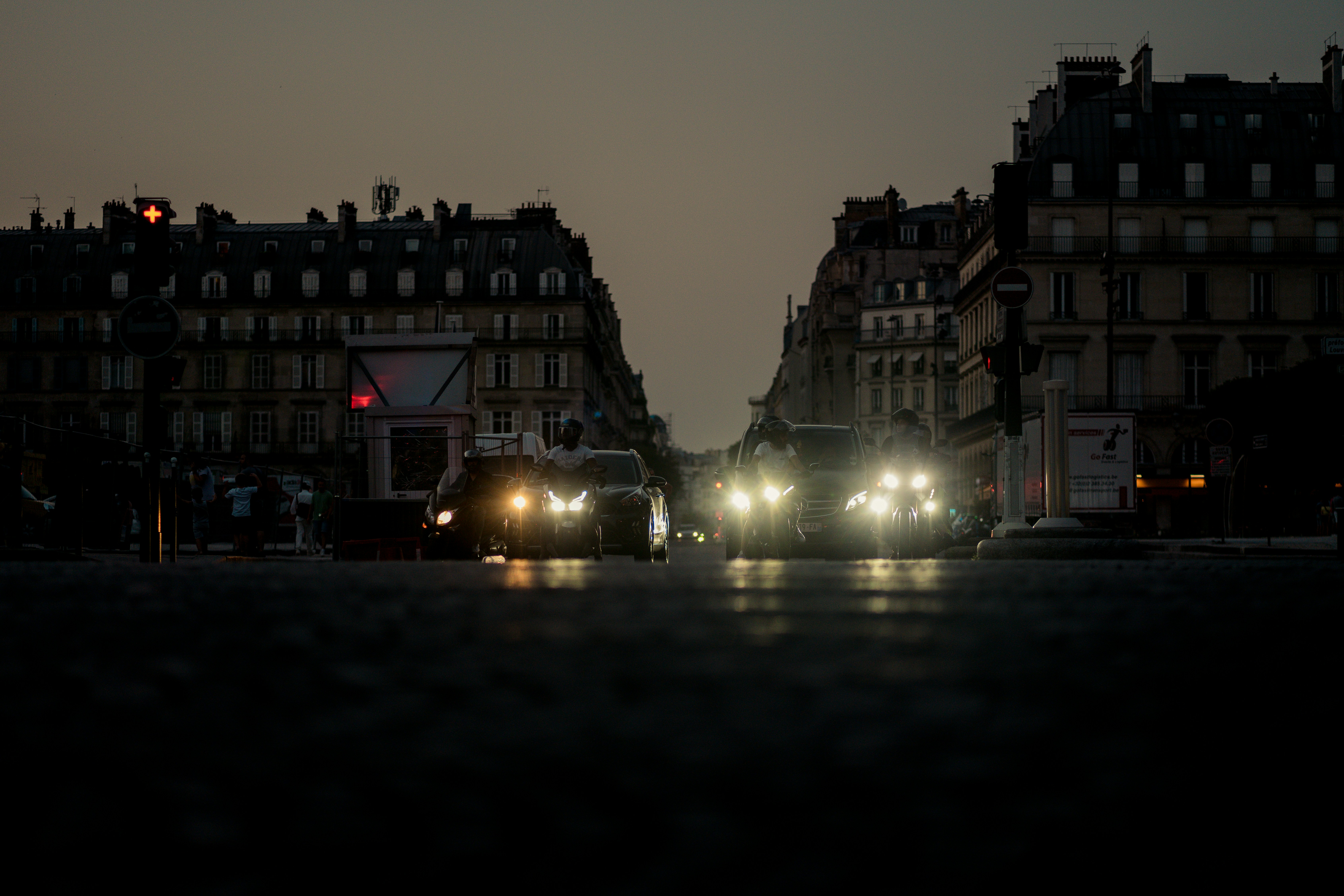 Dusk Headlight Corridor on a Quiet European Street