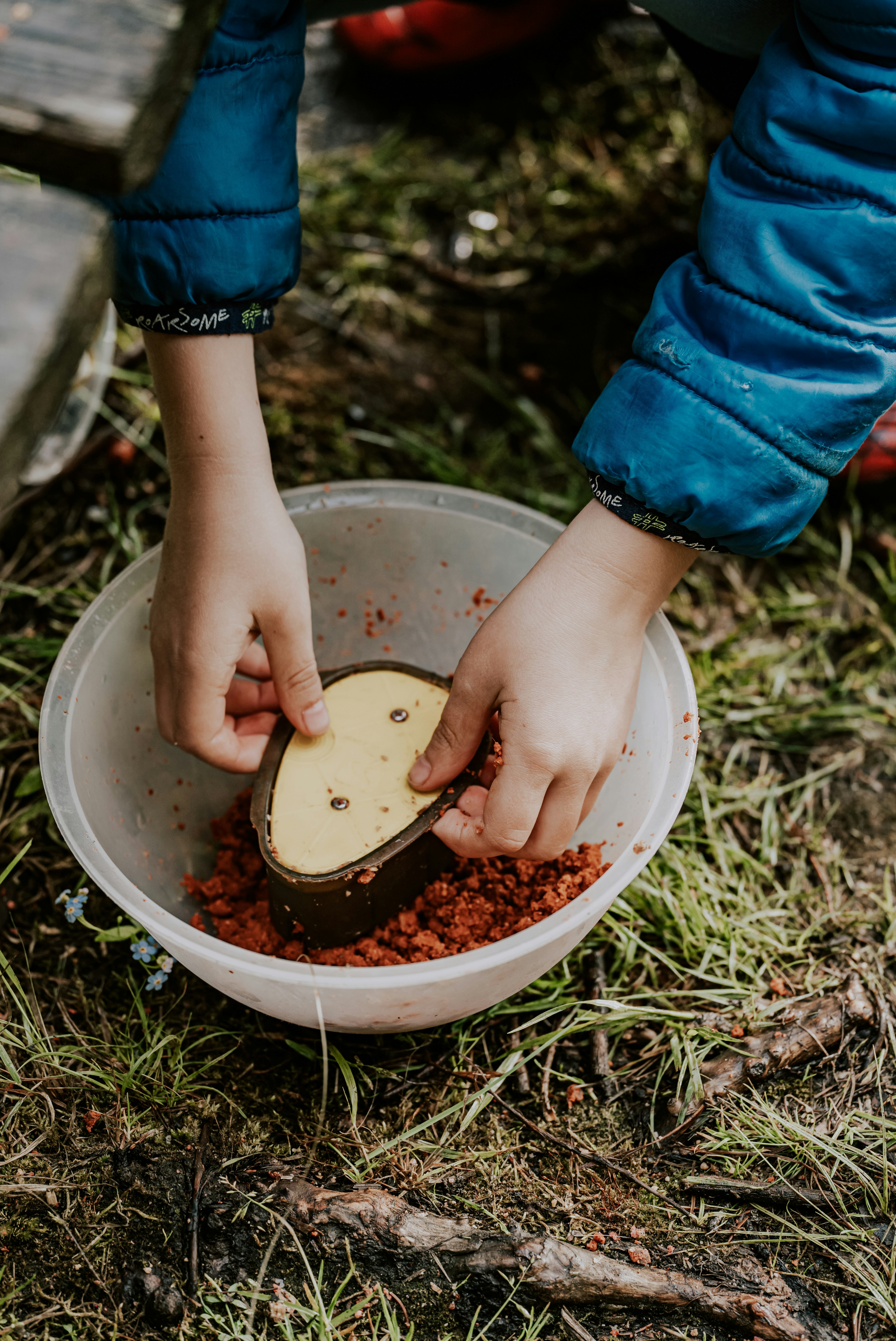 Hands at Work: Preparing Avocado in a Rough Outdoor Bowl