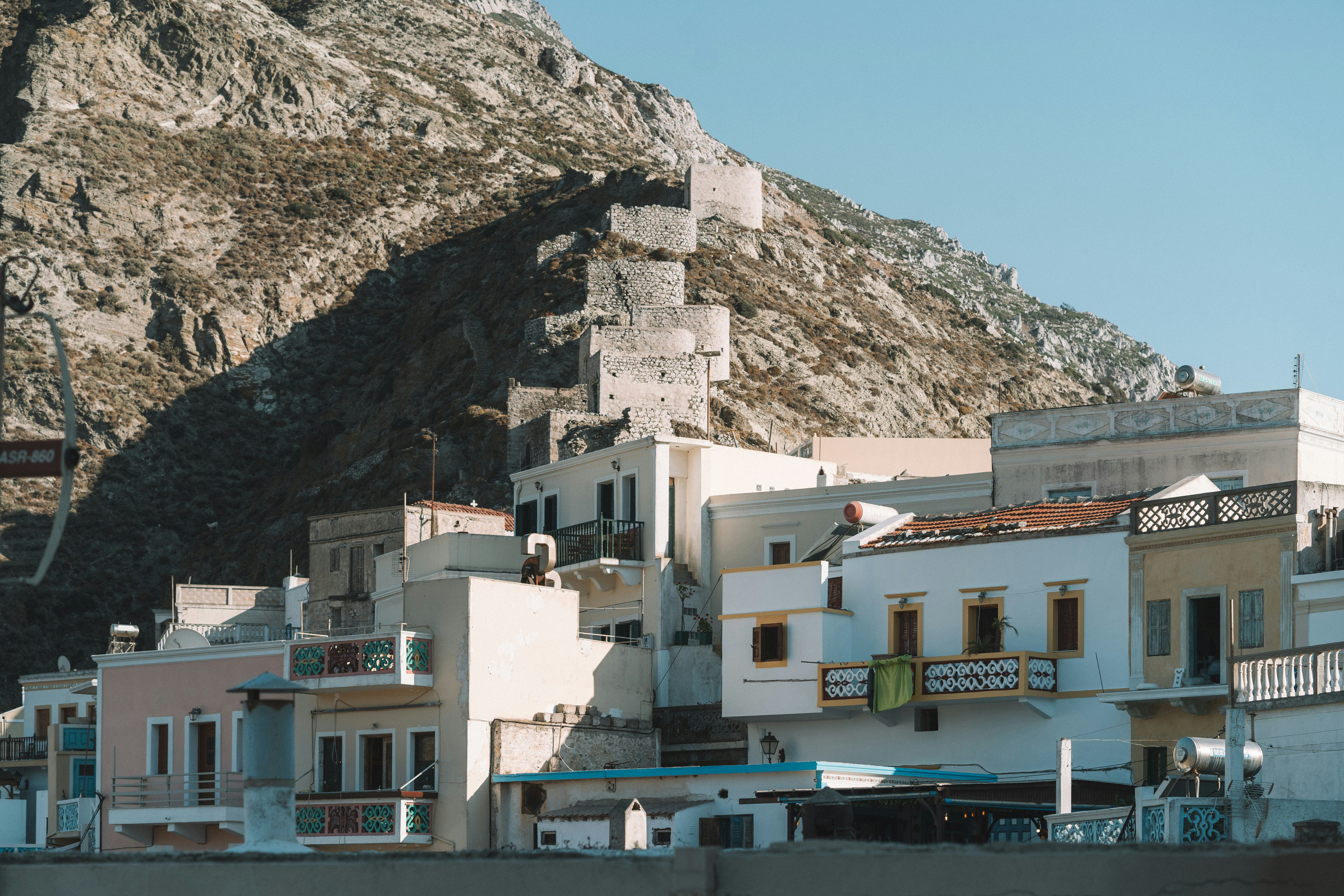 a group of buildings in front of a rocky mountain