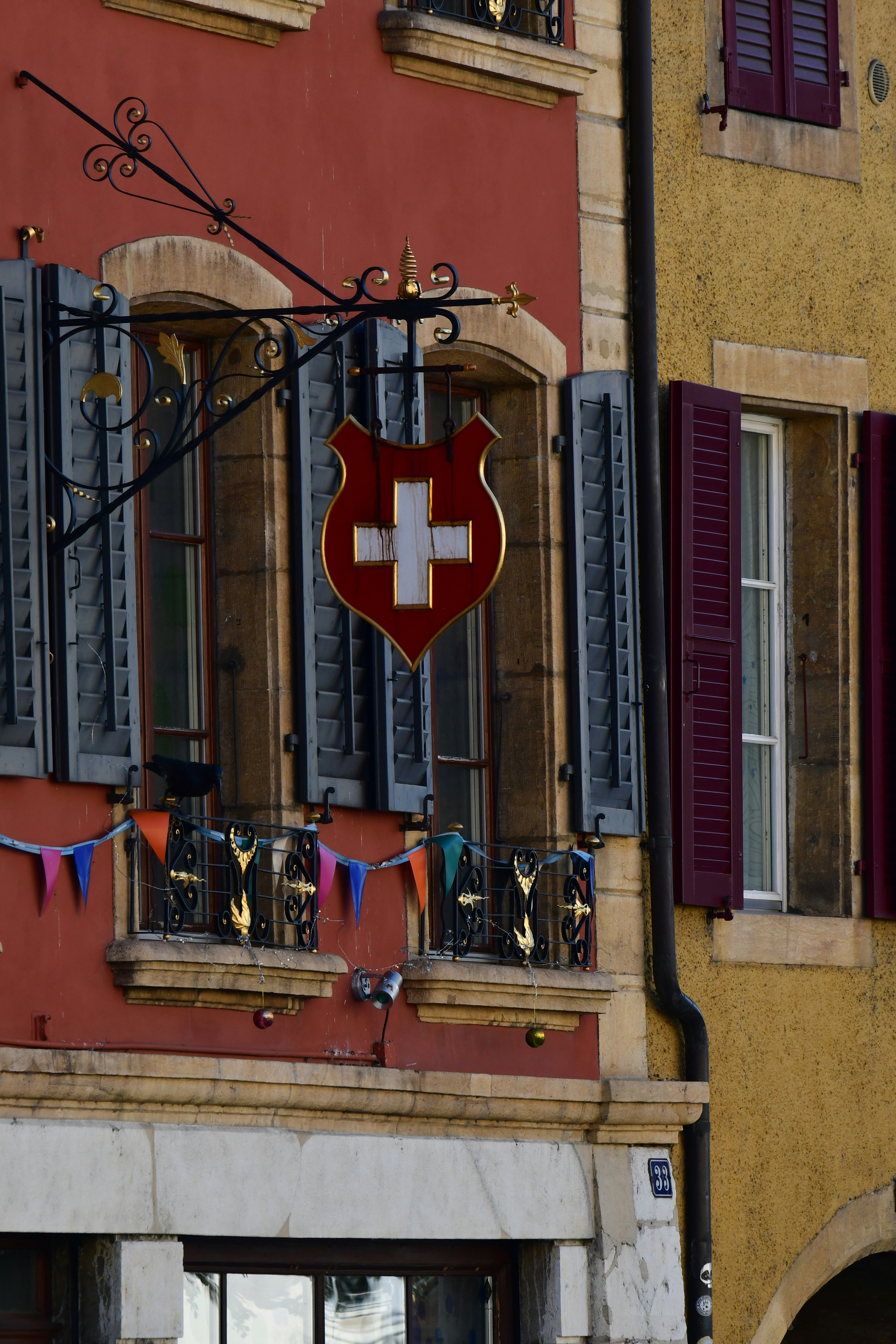 The Swiss Shield Over a Colorful European Façade