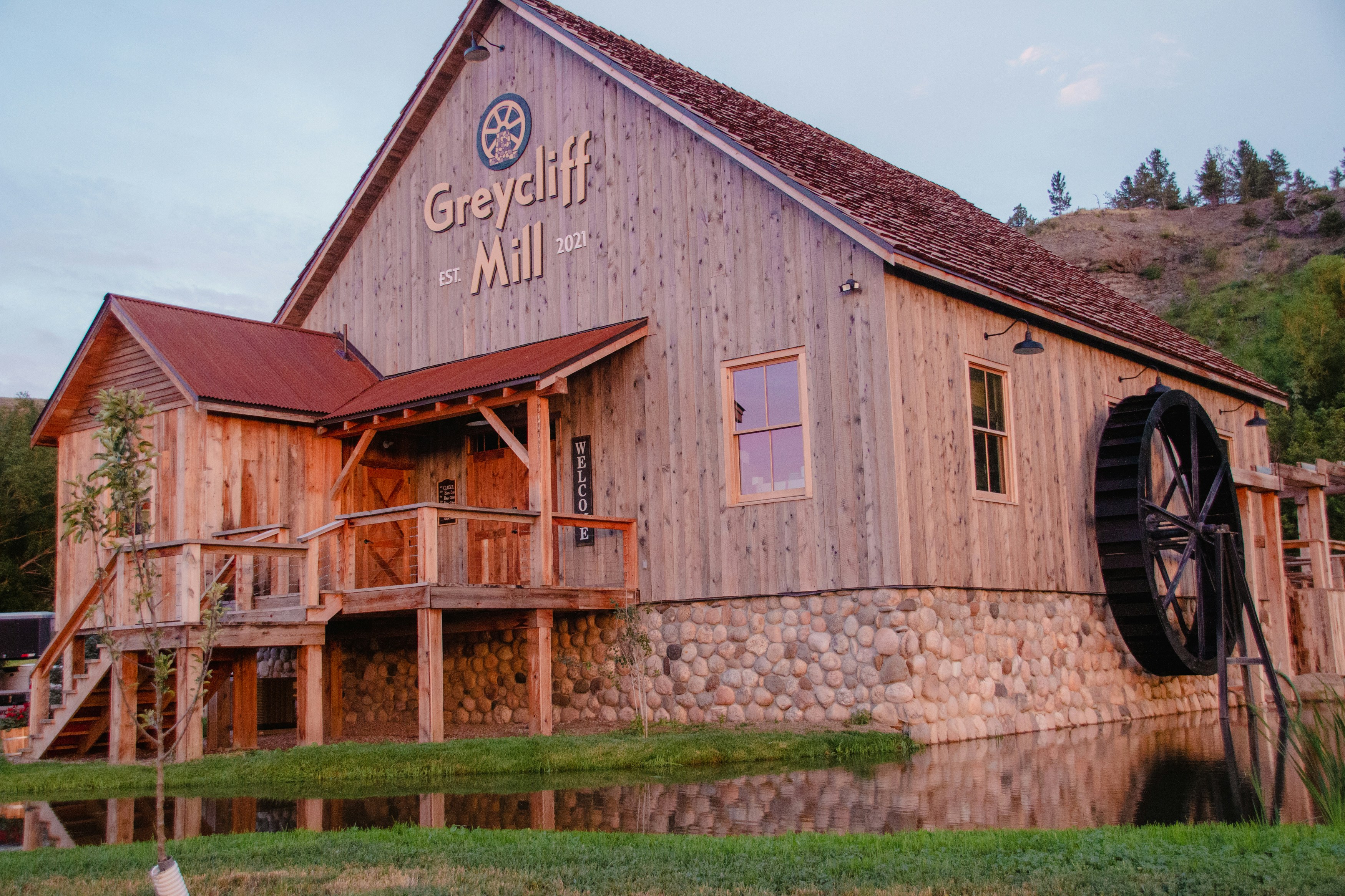 A wooden building with a wheel photo – Free Greycliff mill Image on ...